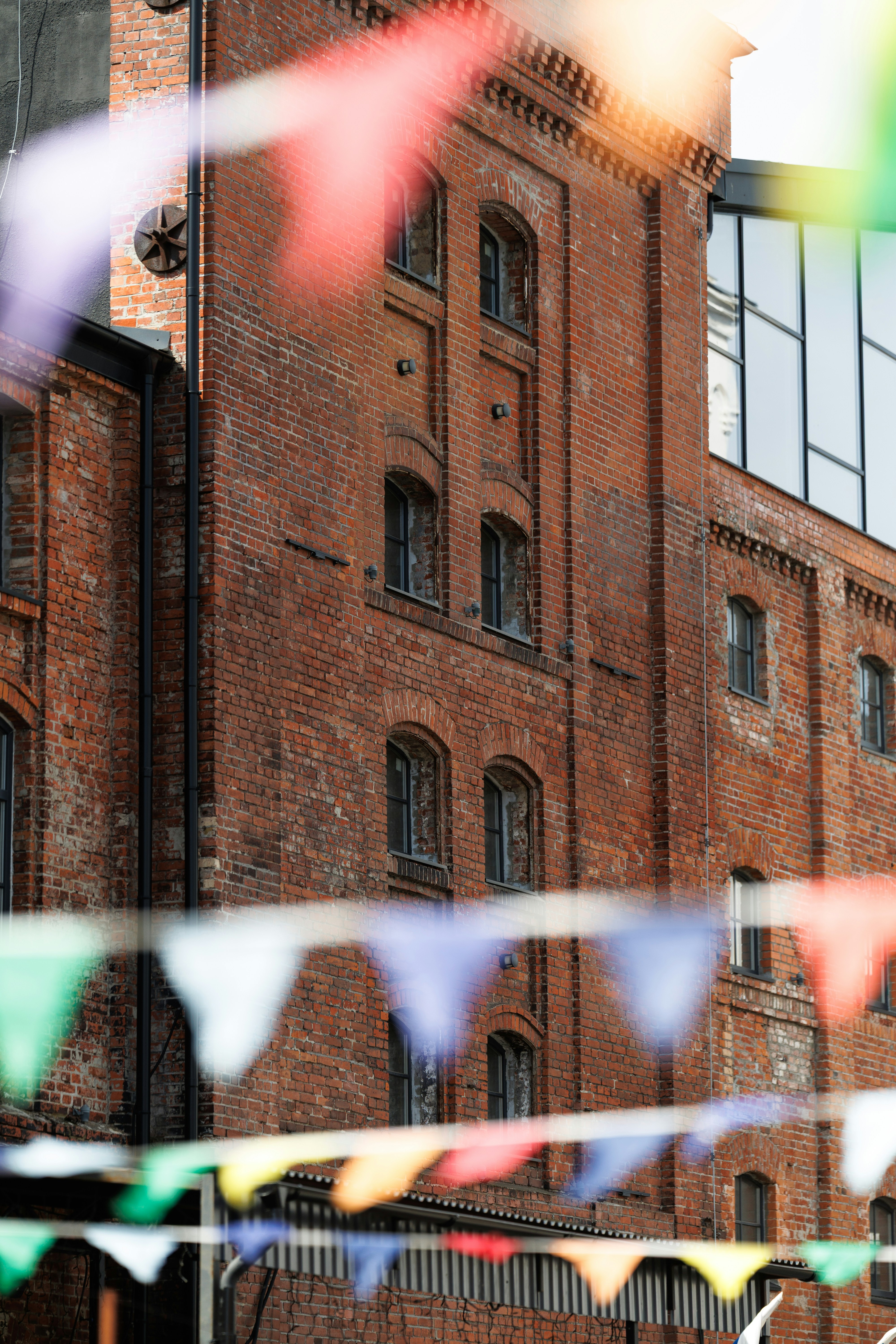 Brick Wonder: Urban Factory Facade framed by Festive Banners
