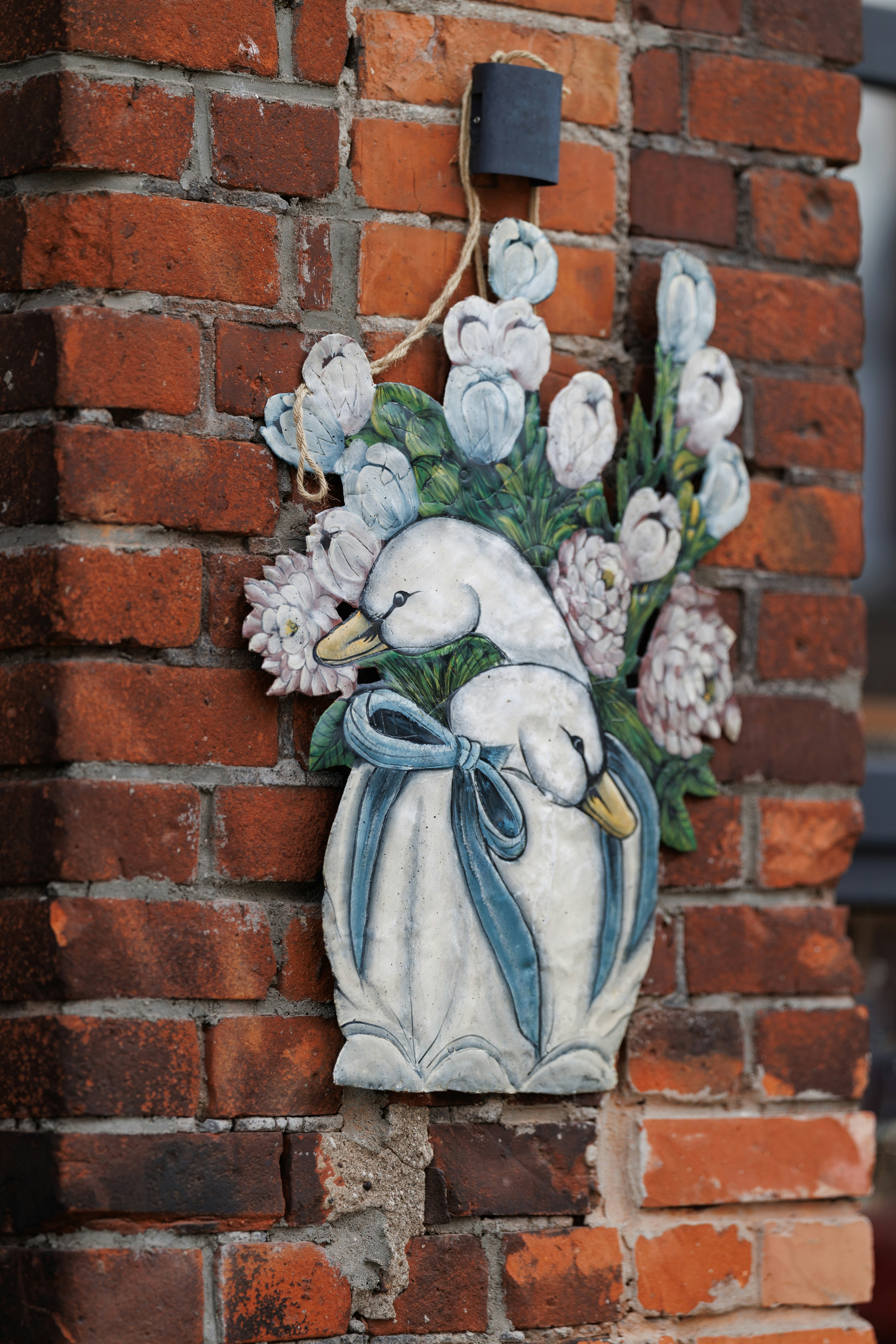 Duck with Bouquet: A Painted Sign Adorning a Brick Wall