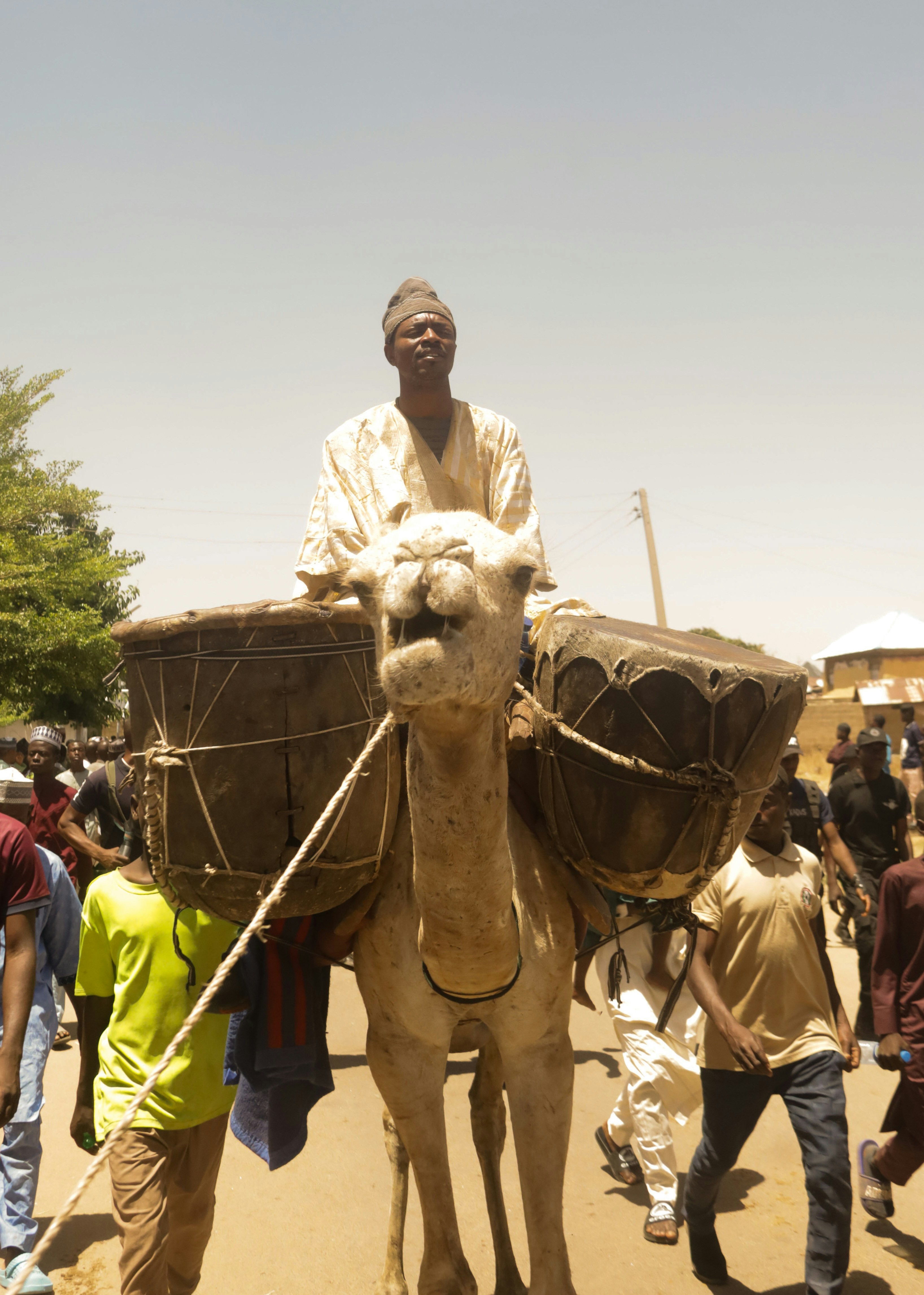 Drummer Rider: A Ferocious Parade on a Dusty Street