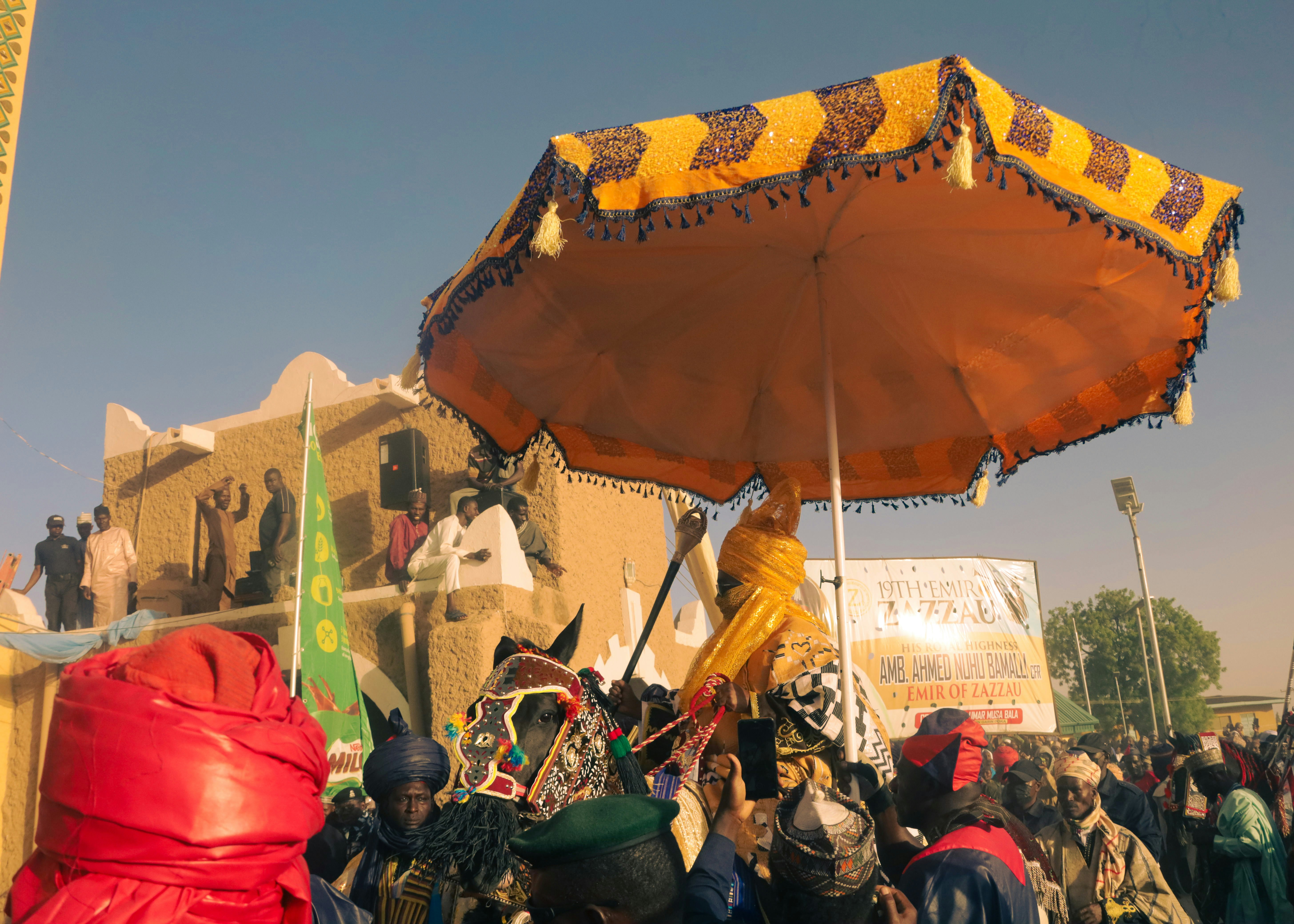 Yellow-ornamented canopy over a crowded festival stage