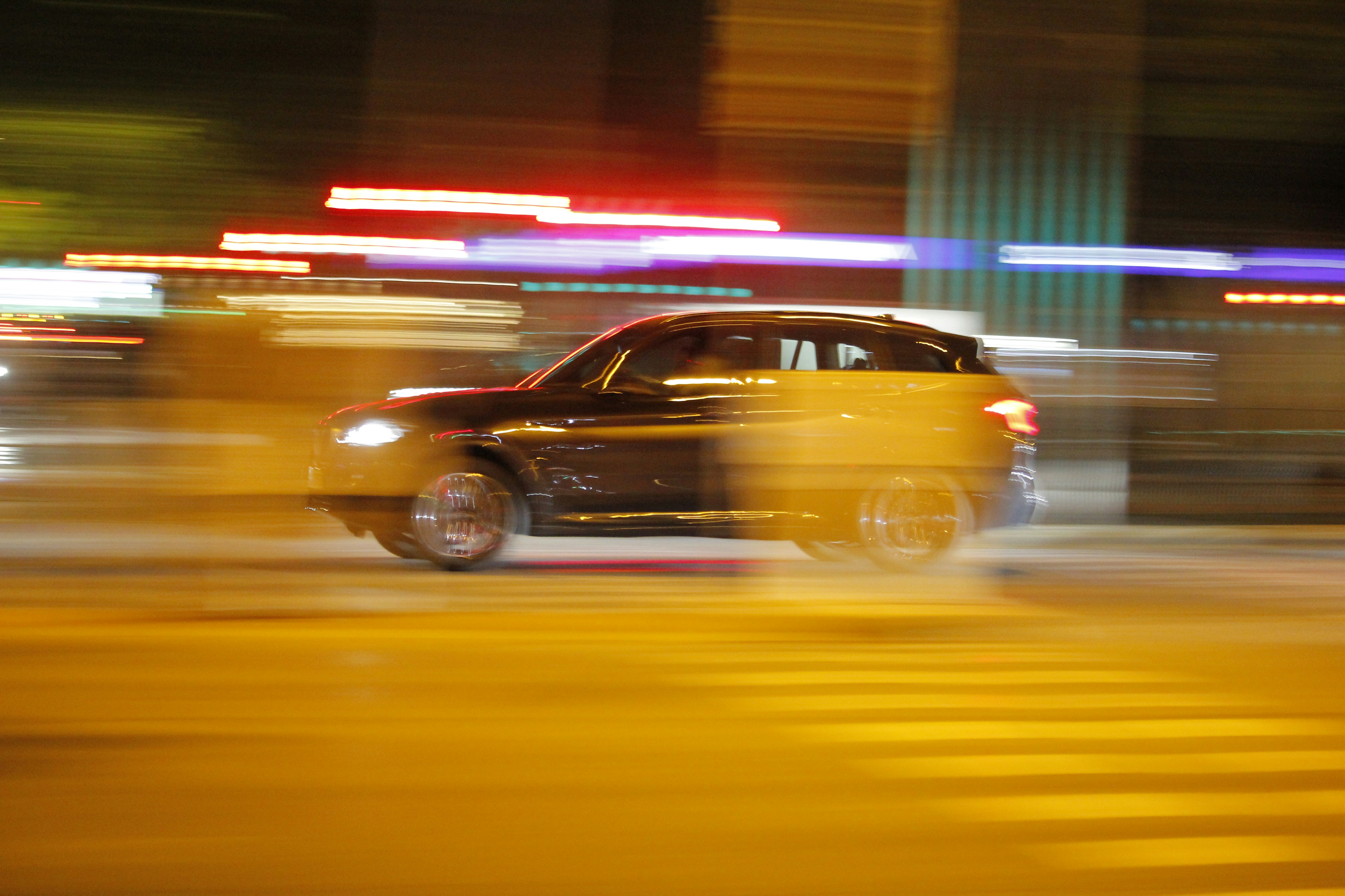 City Night in Motion: A Blur of Steel Under Neon