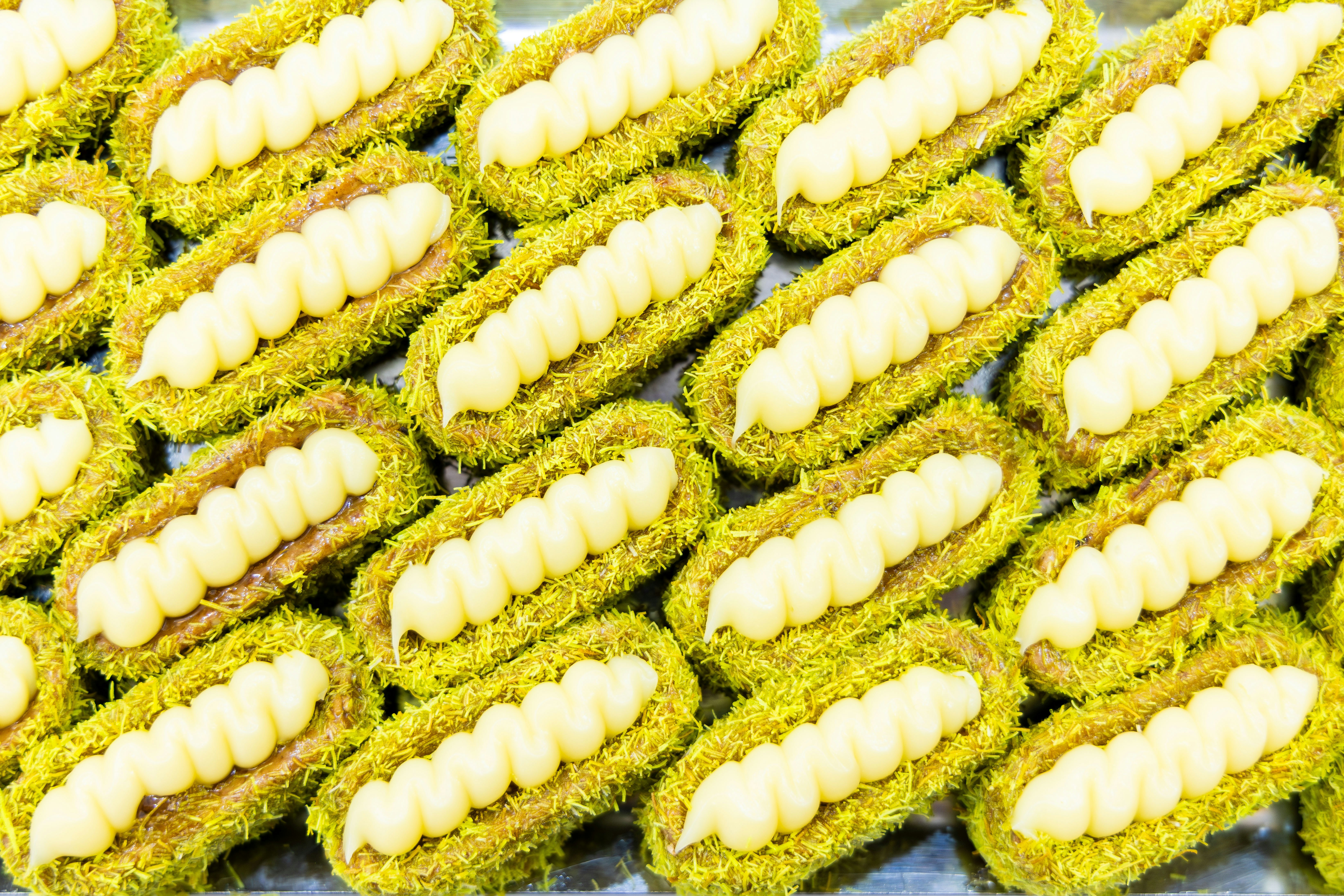 Rows of Creamy Cream-Filled Frills: A Macro Patchwork of Pastry Delights