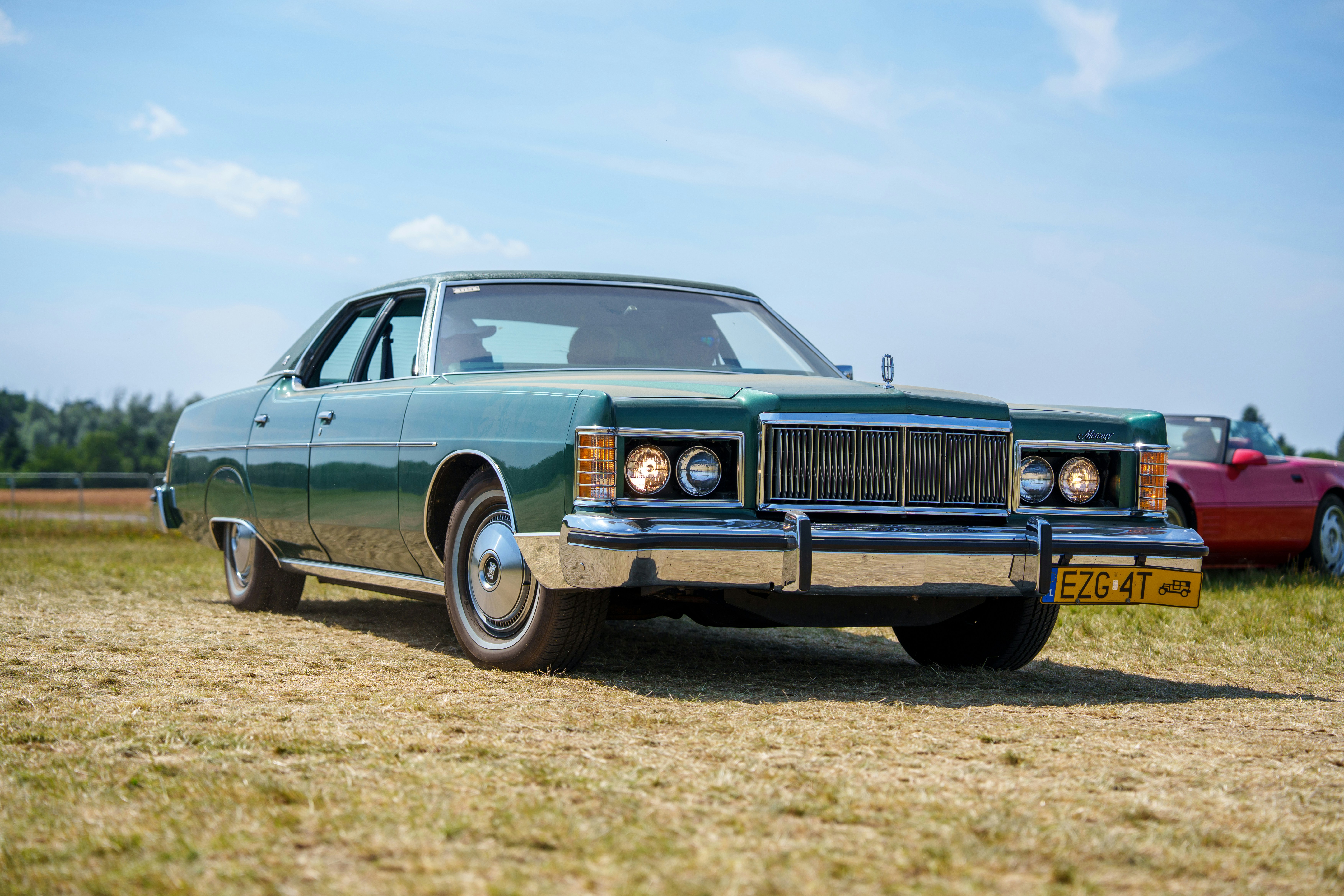 Midday Stance: A Vintage Green Sedan Resting on Dry Field