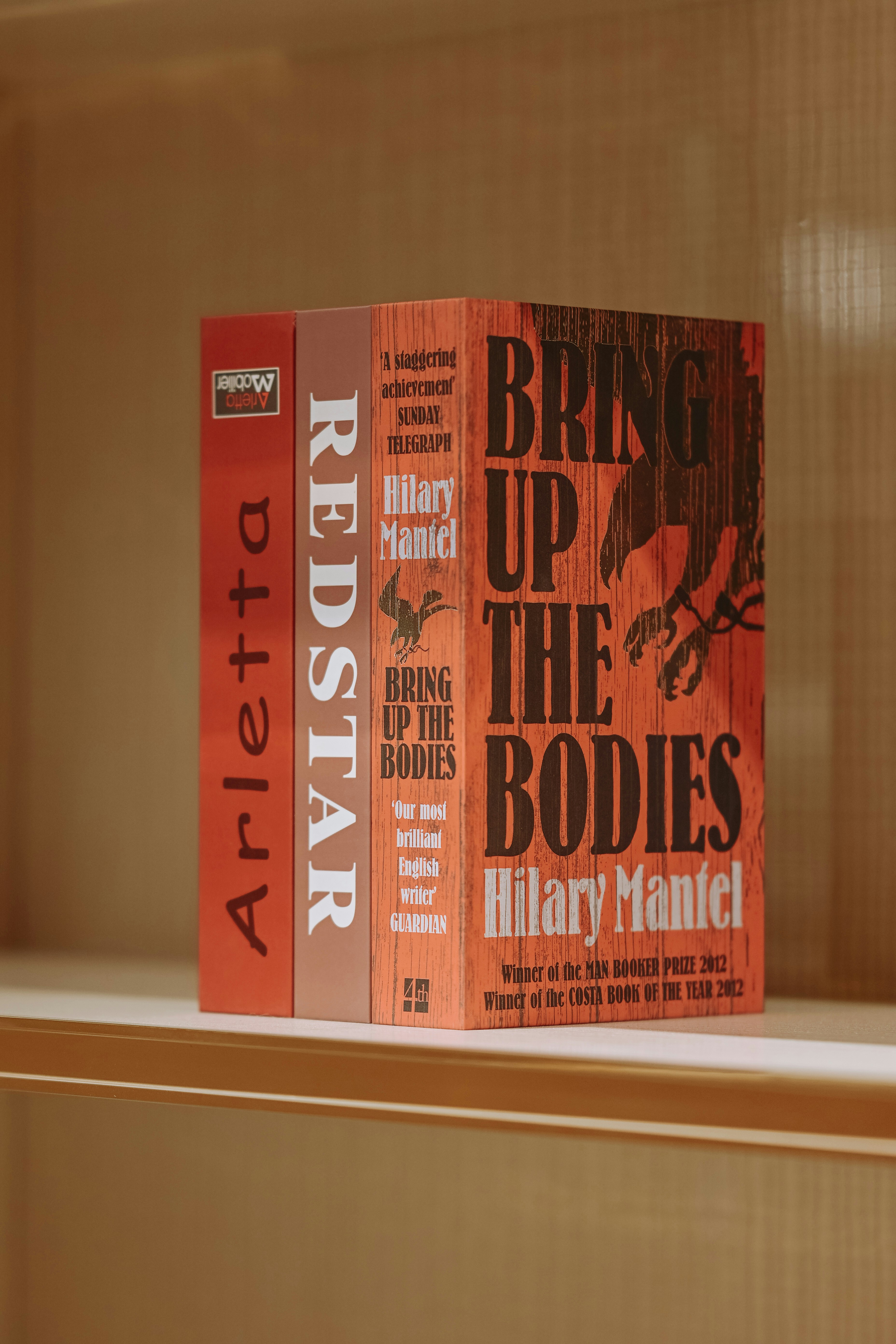 Shelf of Red-Orange Book Spines: Bring Up the Bodies