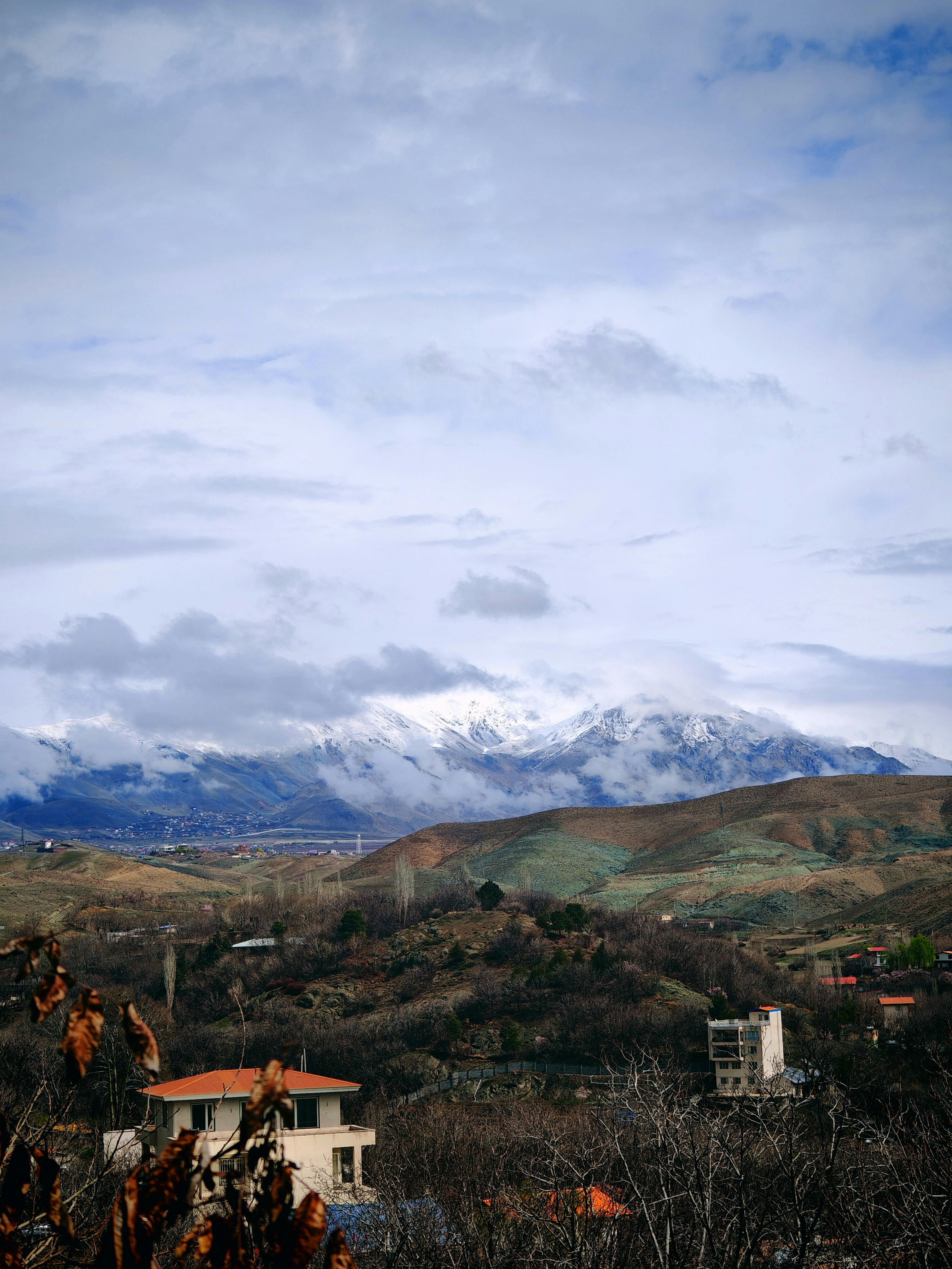 Snowy ridges at dusk over a quiet hillside town