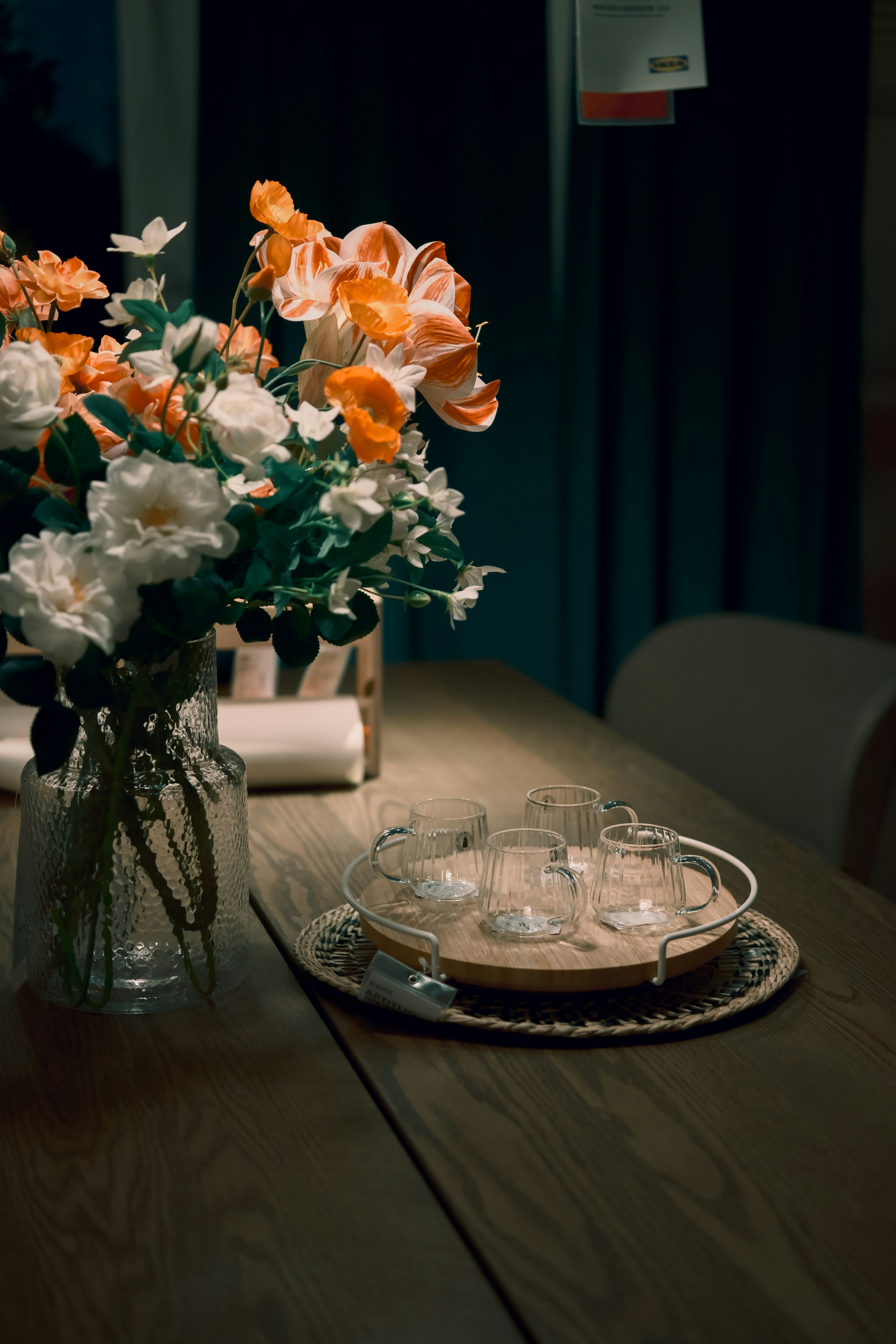 Orange-and-White Floral Bouquet on a Dimly Lit Dining Table