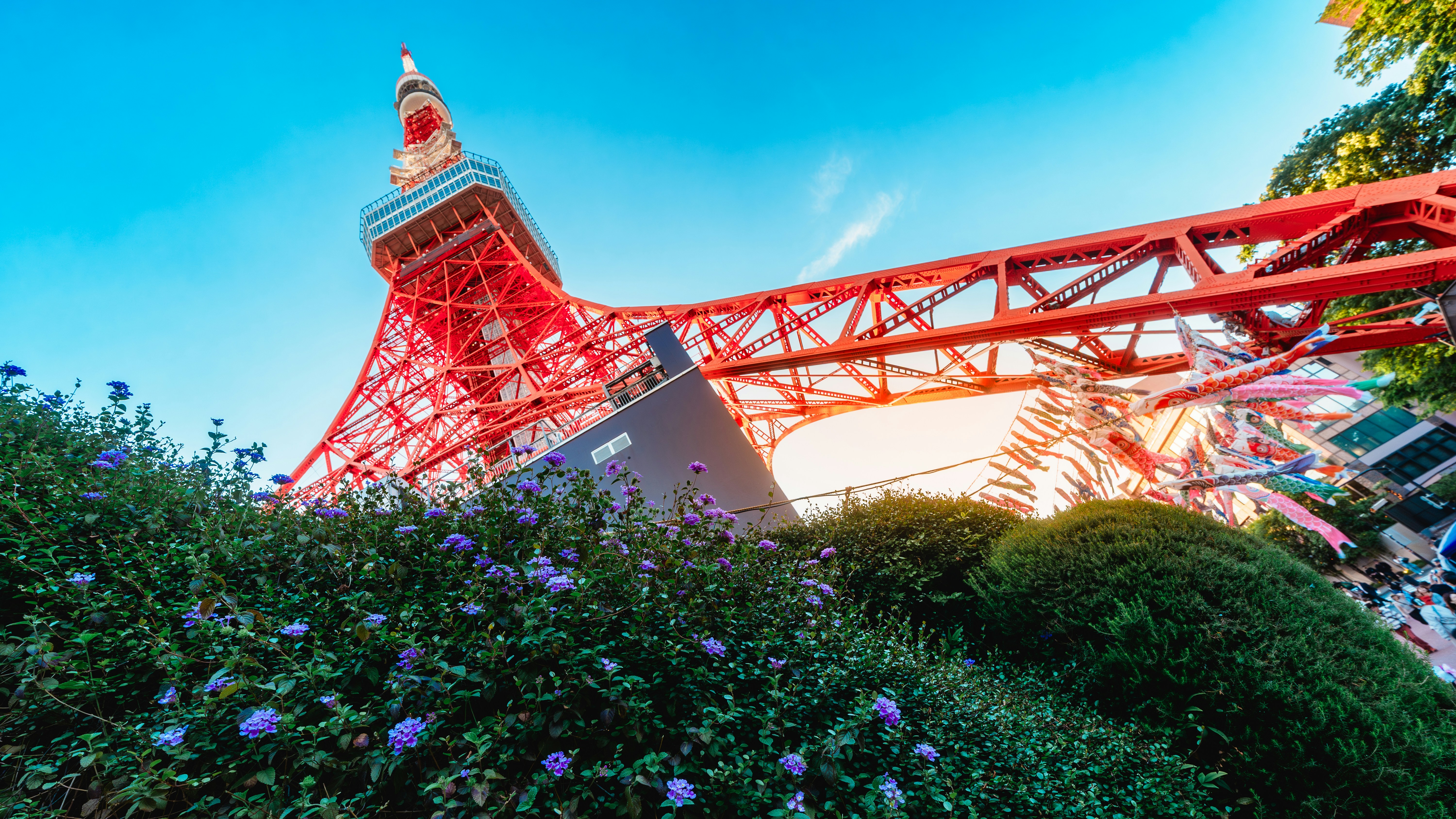 Red Steel Spire Soaring Above a Flowering Park