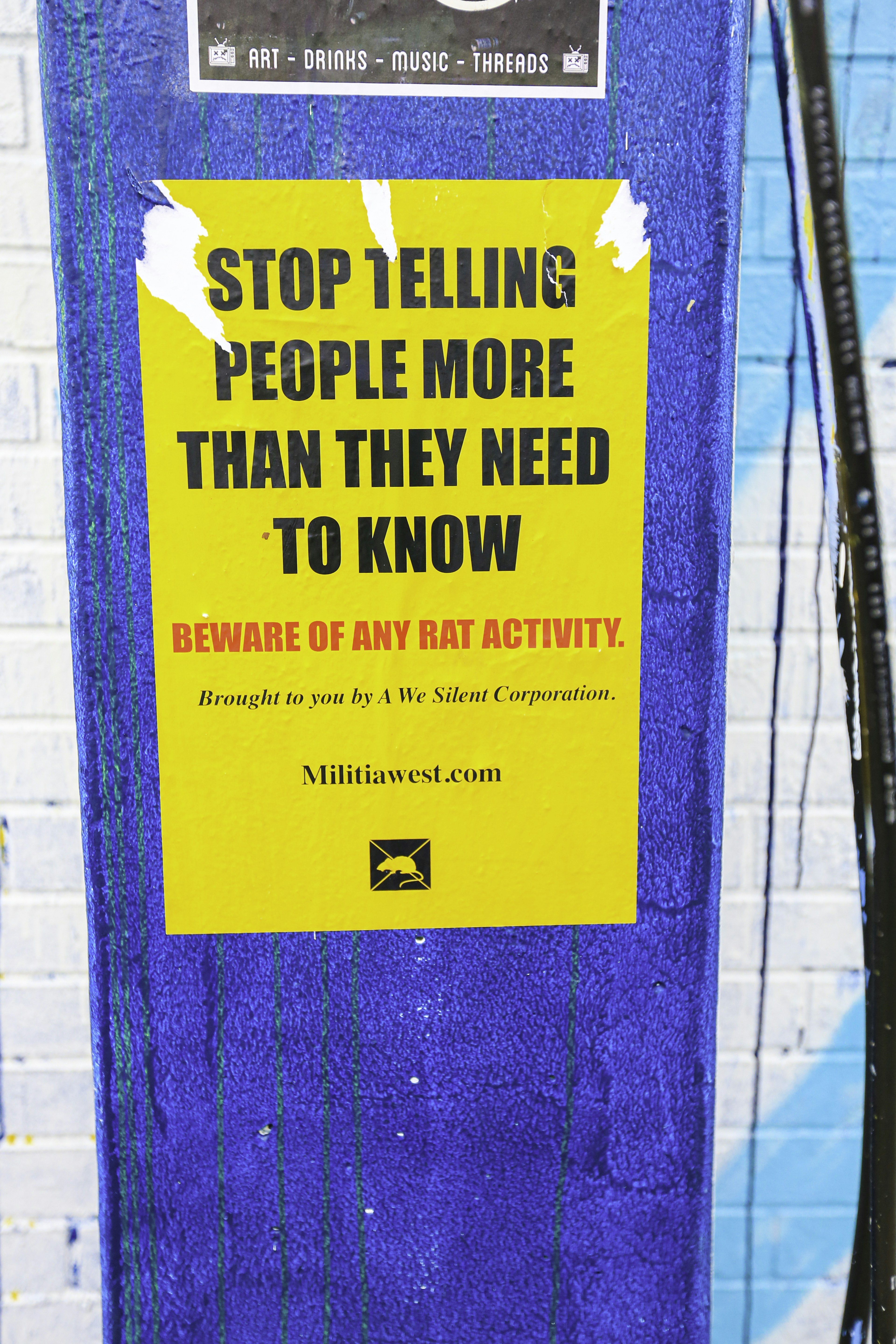Bold Yellow Advisory Stuck on a Blue Utility Post