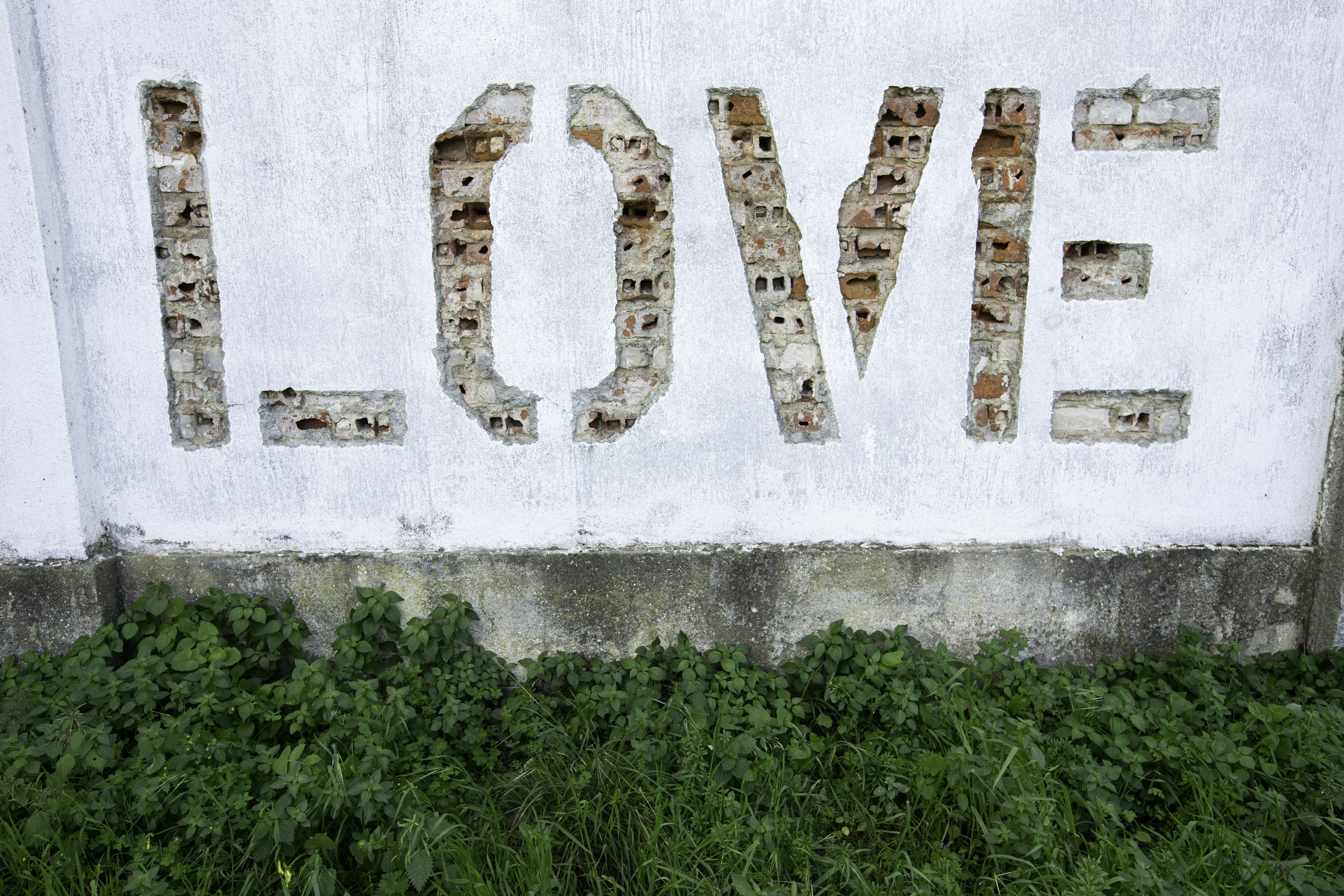 Love in Bricks: The Word Carved by Weathered Hands