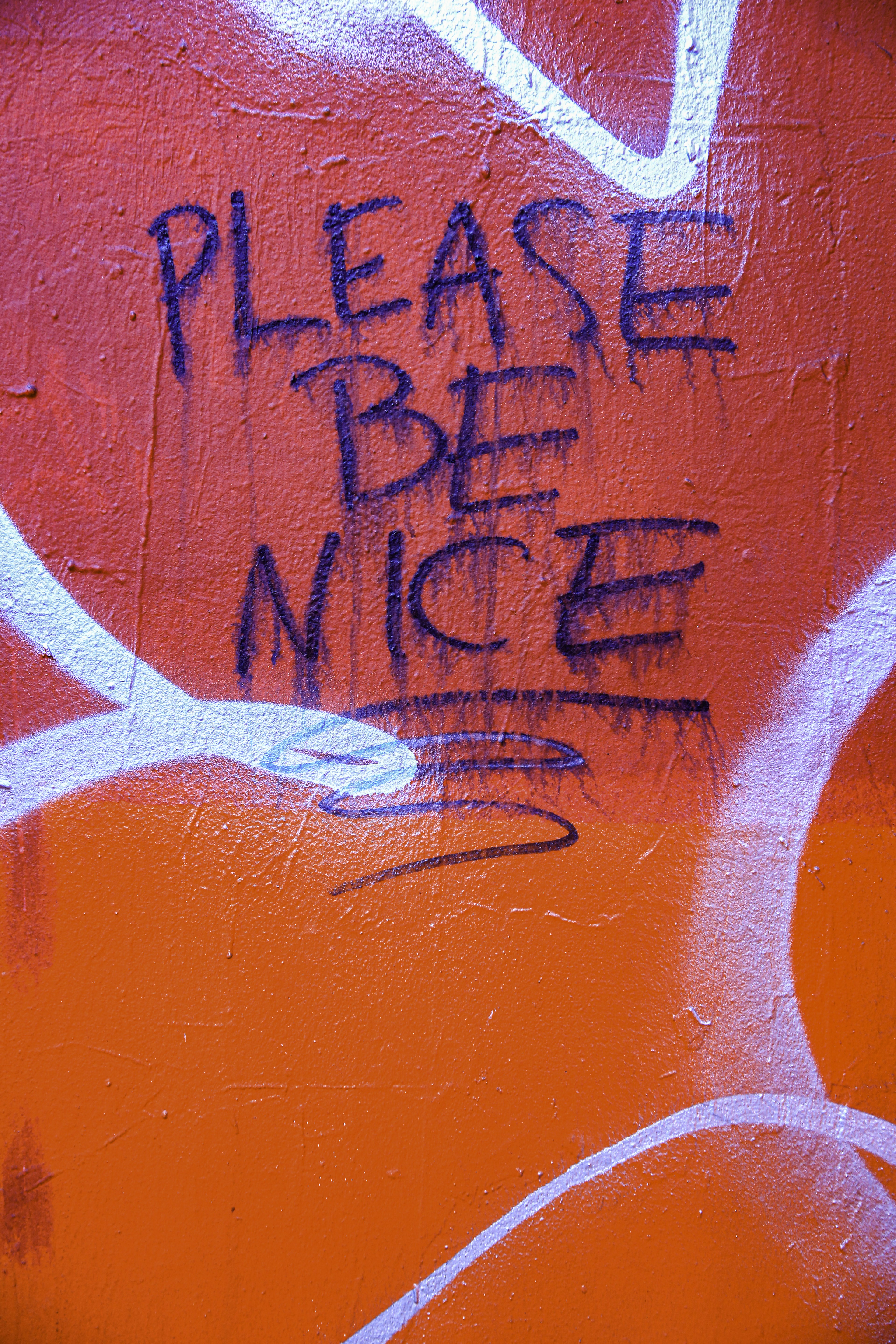 Graffiti Message on Vivid Red Wall