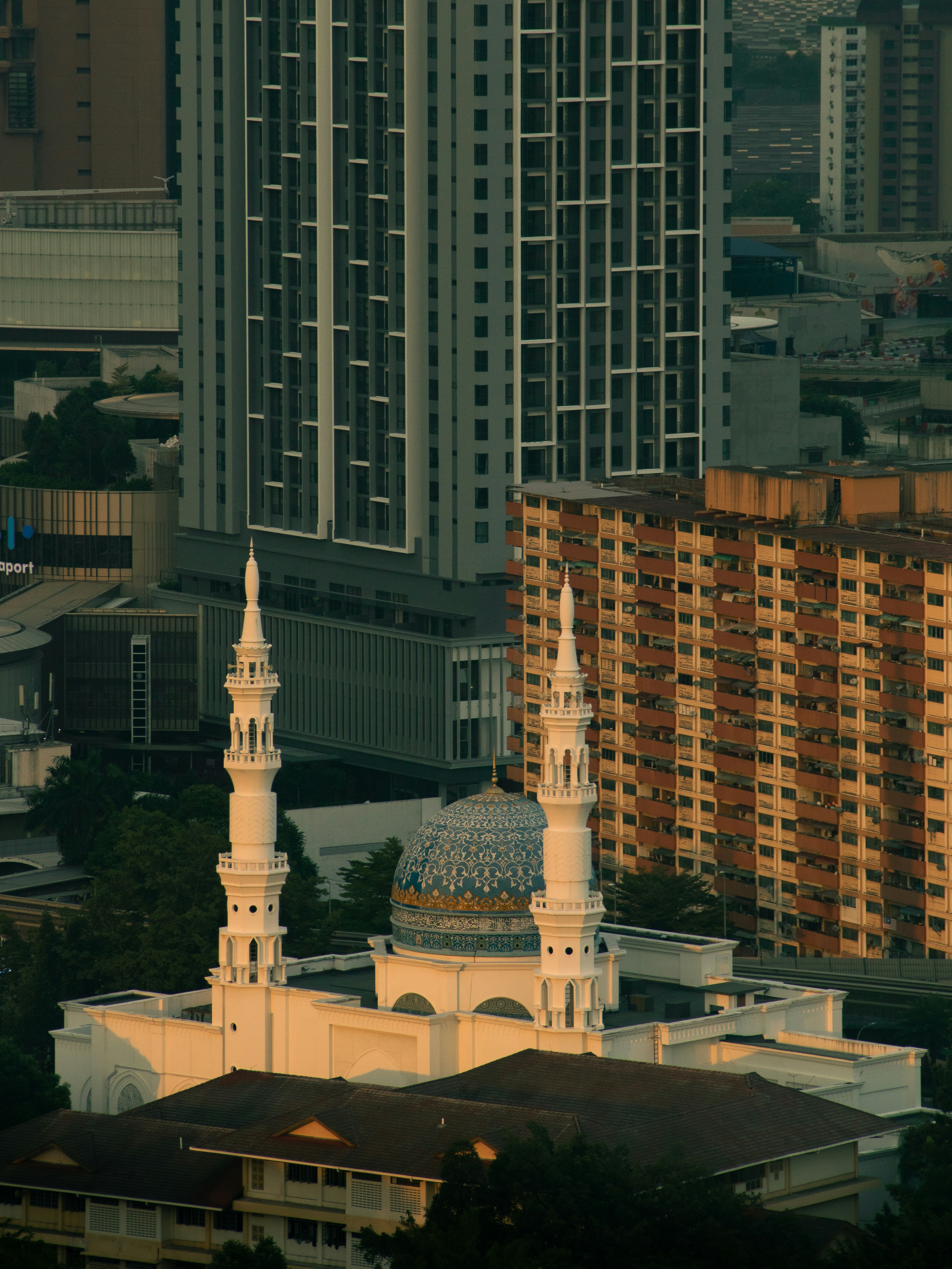 Domed Mosque Amid Glass-Ckeleton Towers