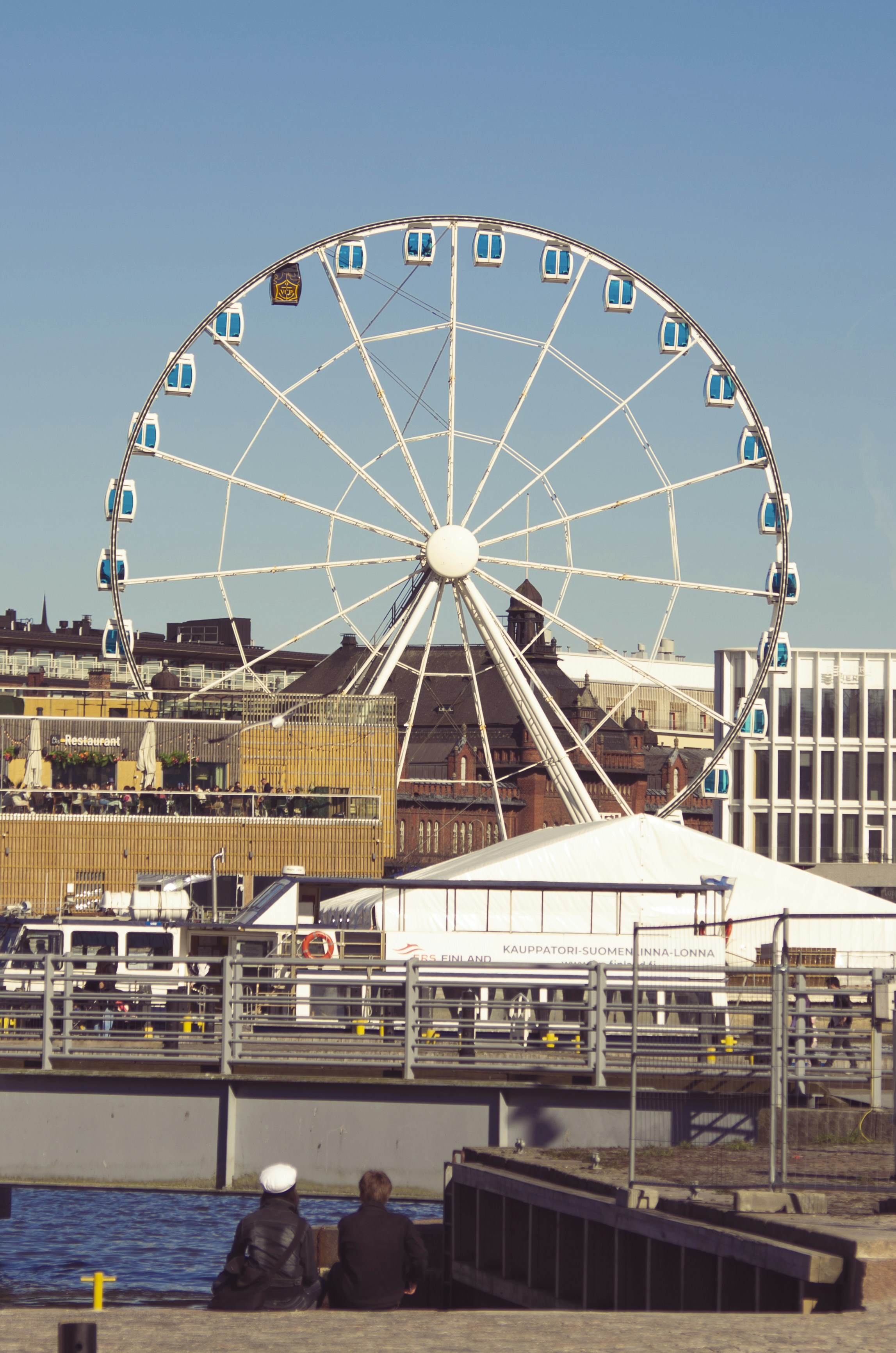 Midday Carousel: A Ferris Wheel Over the Boats