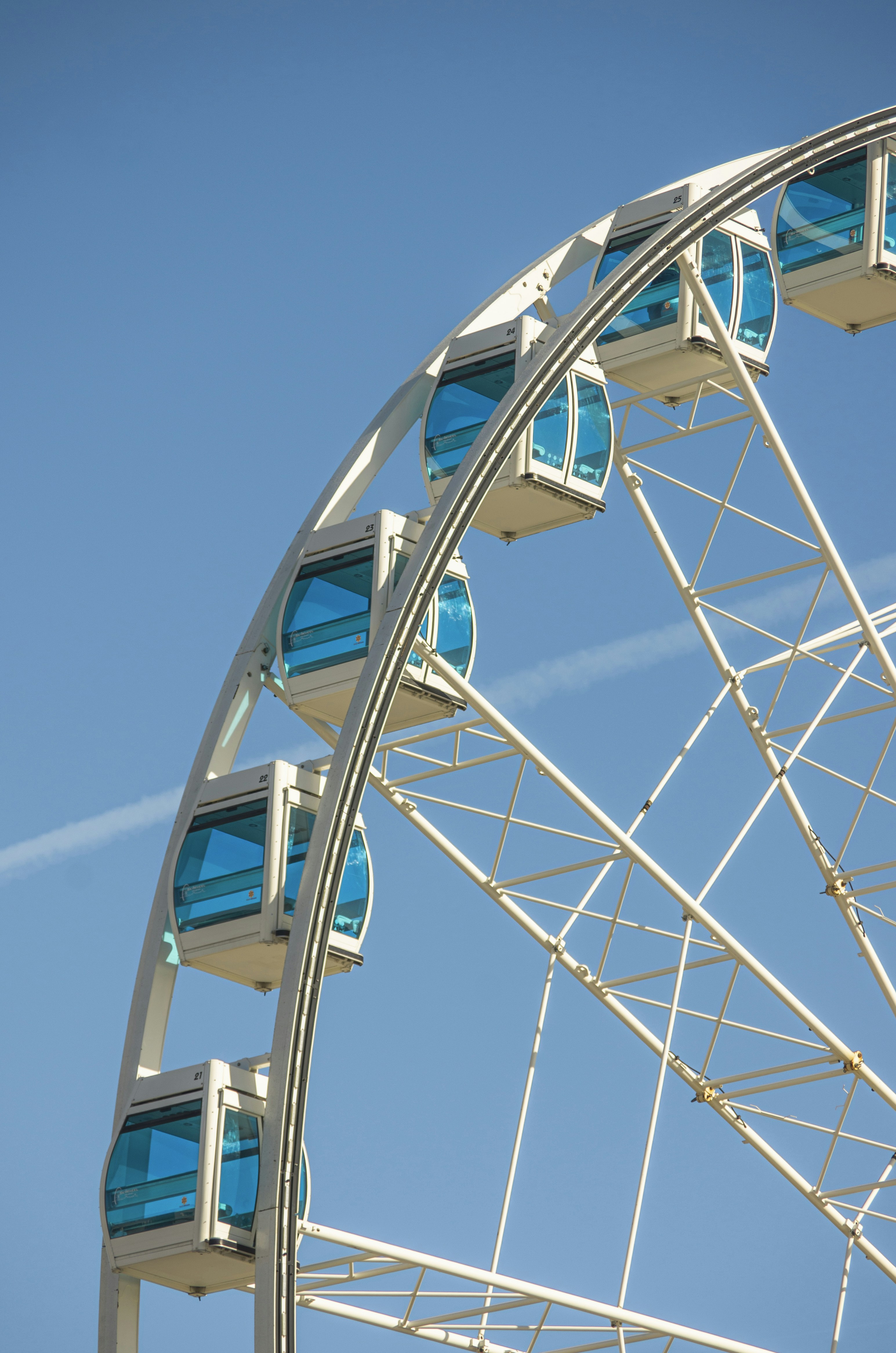 Skyward Wheel: A Ferris Frame Against a Clear Blue