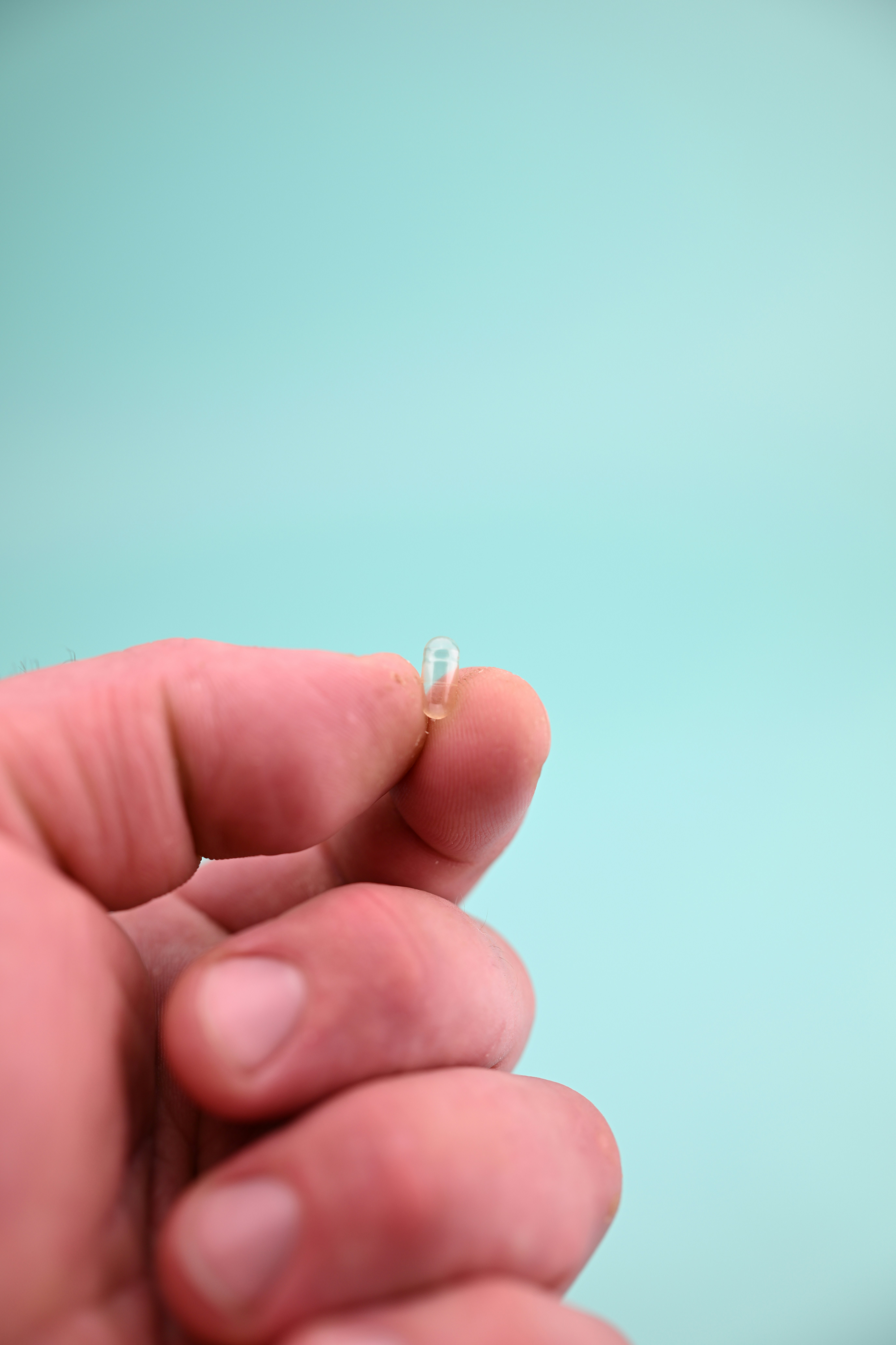 Tiny Crystal Between Fingers: A Miniature Object in Sharp Focus