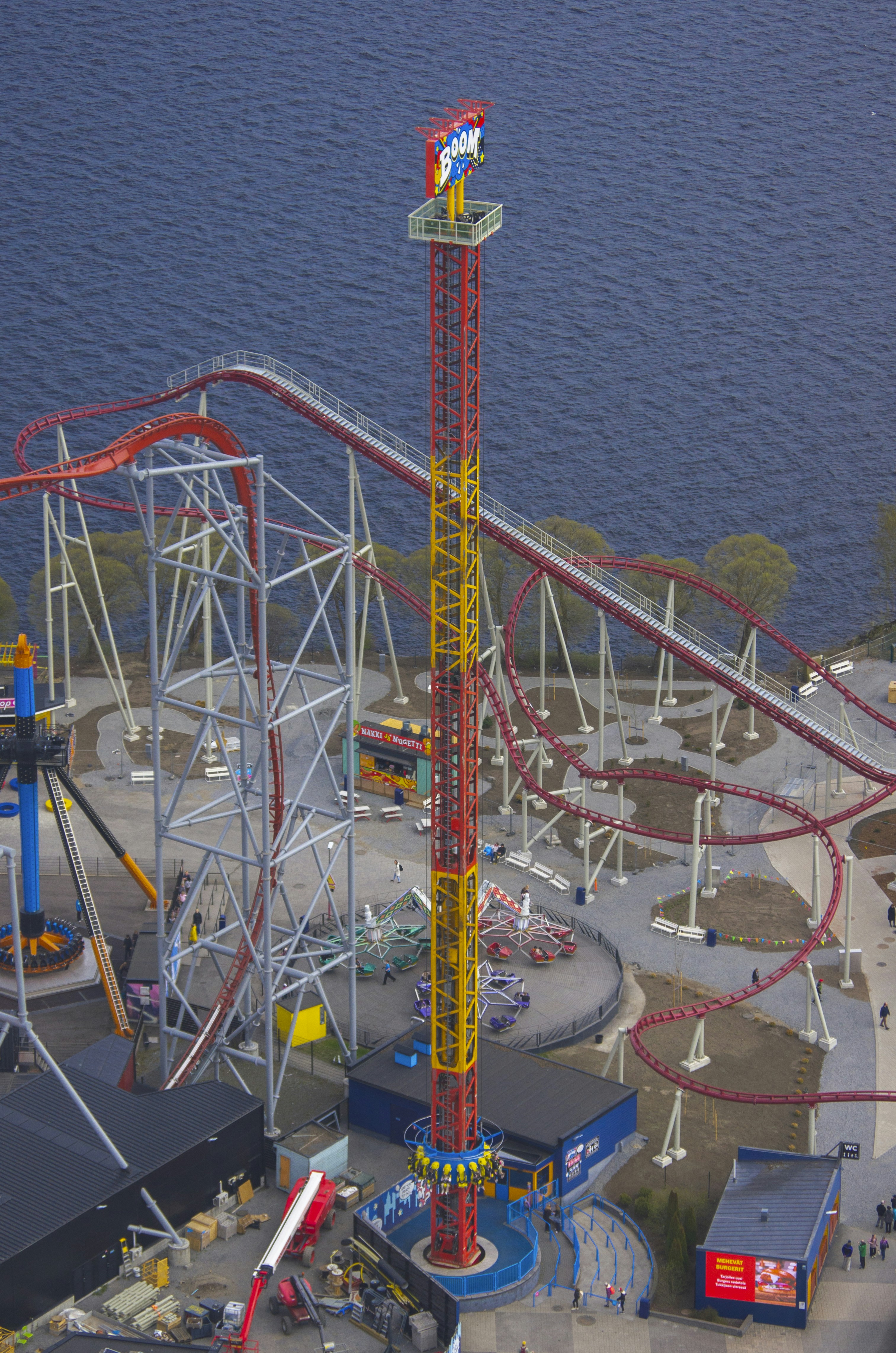 Towering Red-Blue Coaster Tower Over a Miniature Amusement Park