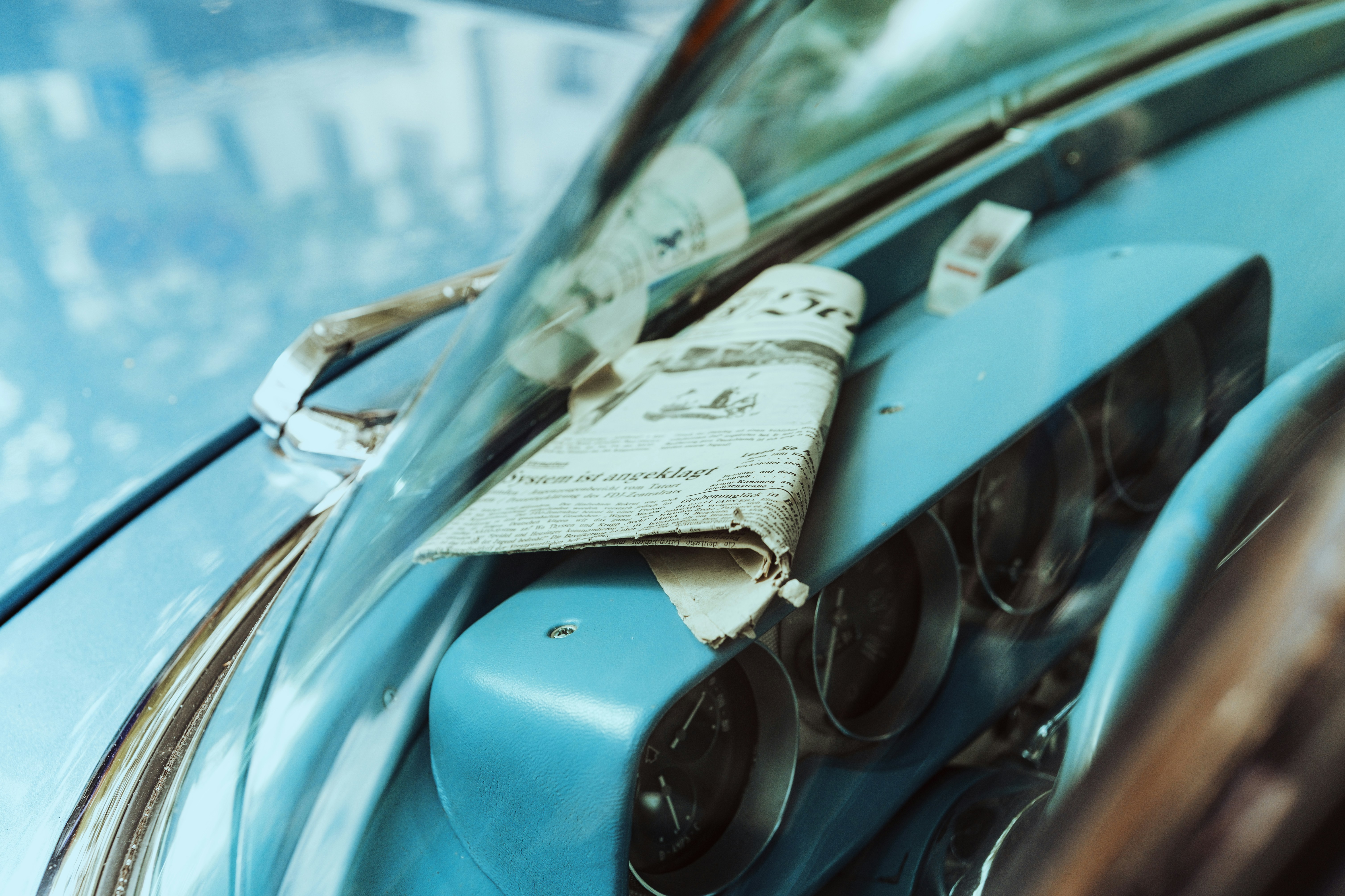 A Glimpse Inside: Weathered Paper on a Vintage Blue Dash