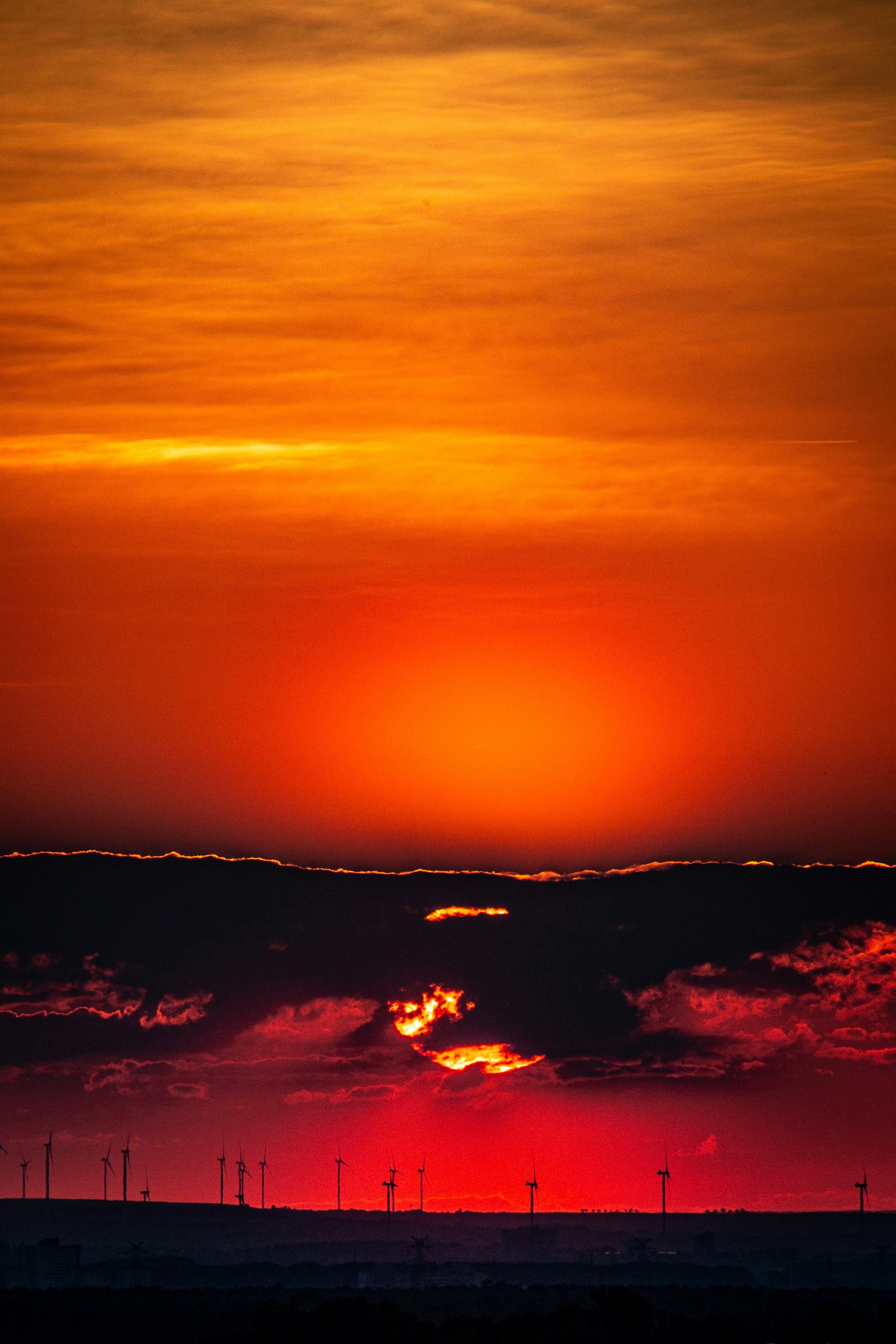 Blazing Horizon: Sunset Over Wind Turbine Silhouettes