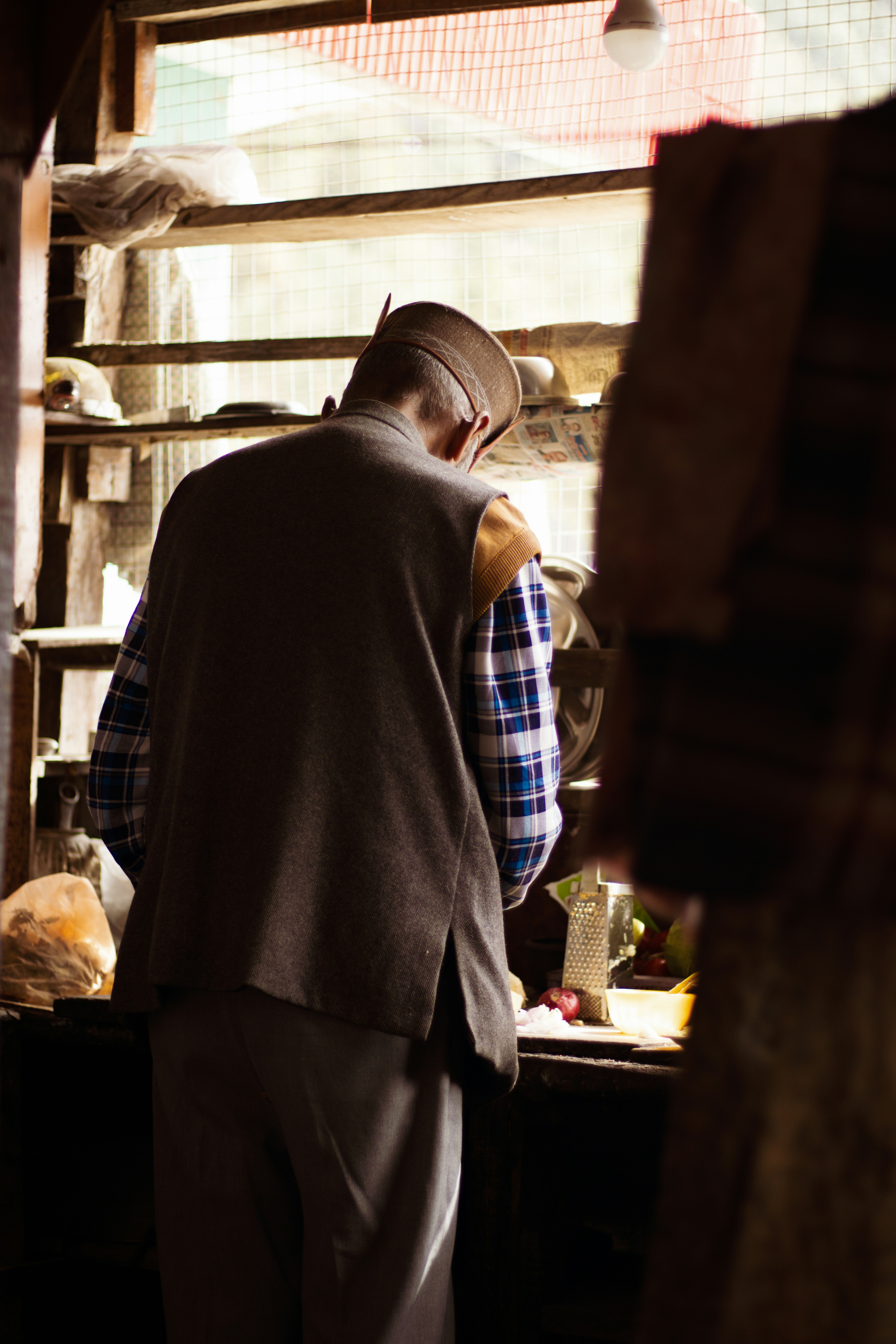 Backlit Gardener in a Dim Workshop