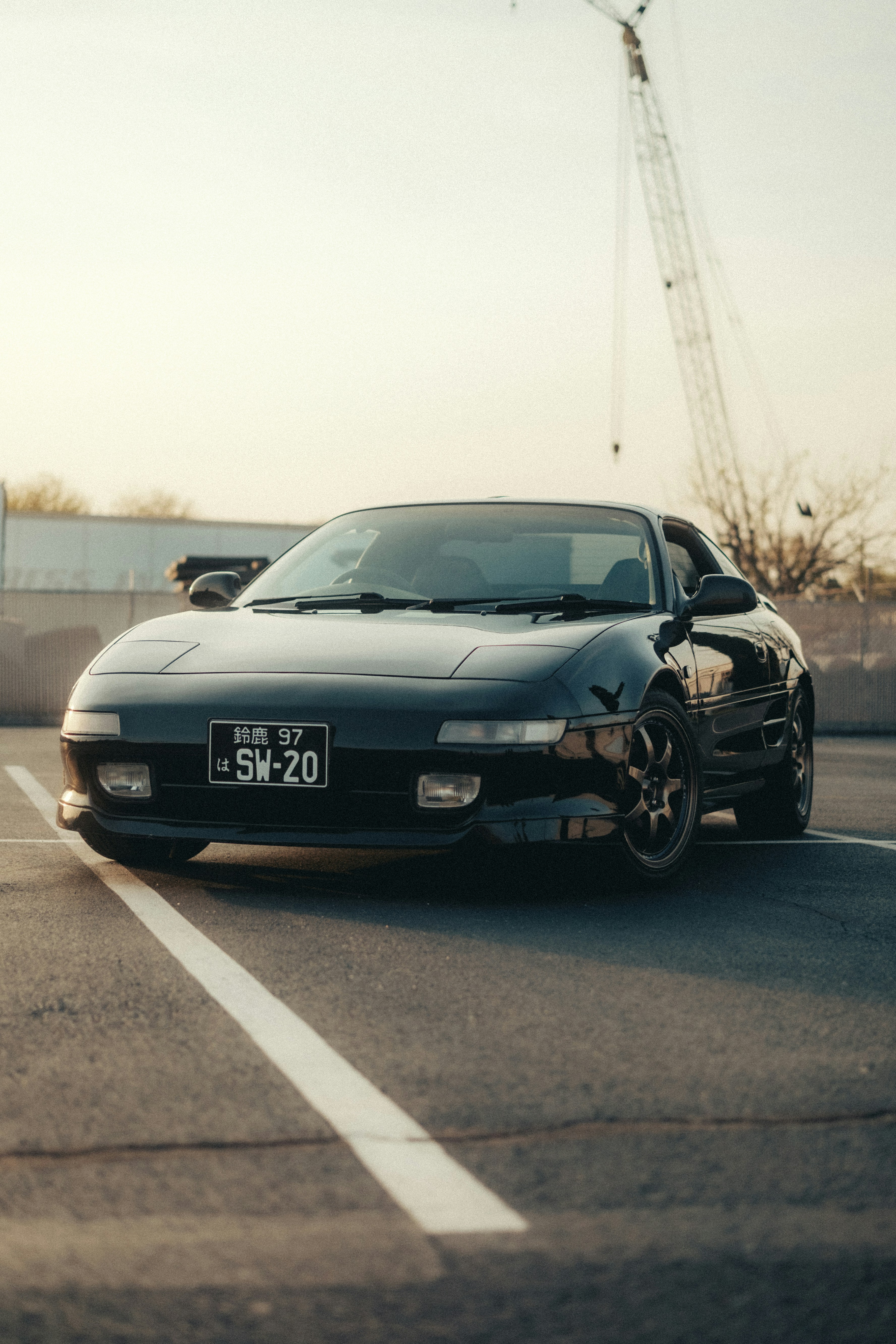Midnight Stance: A Sleek Convertible in an Empty Parking Lot