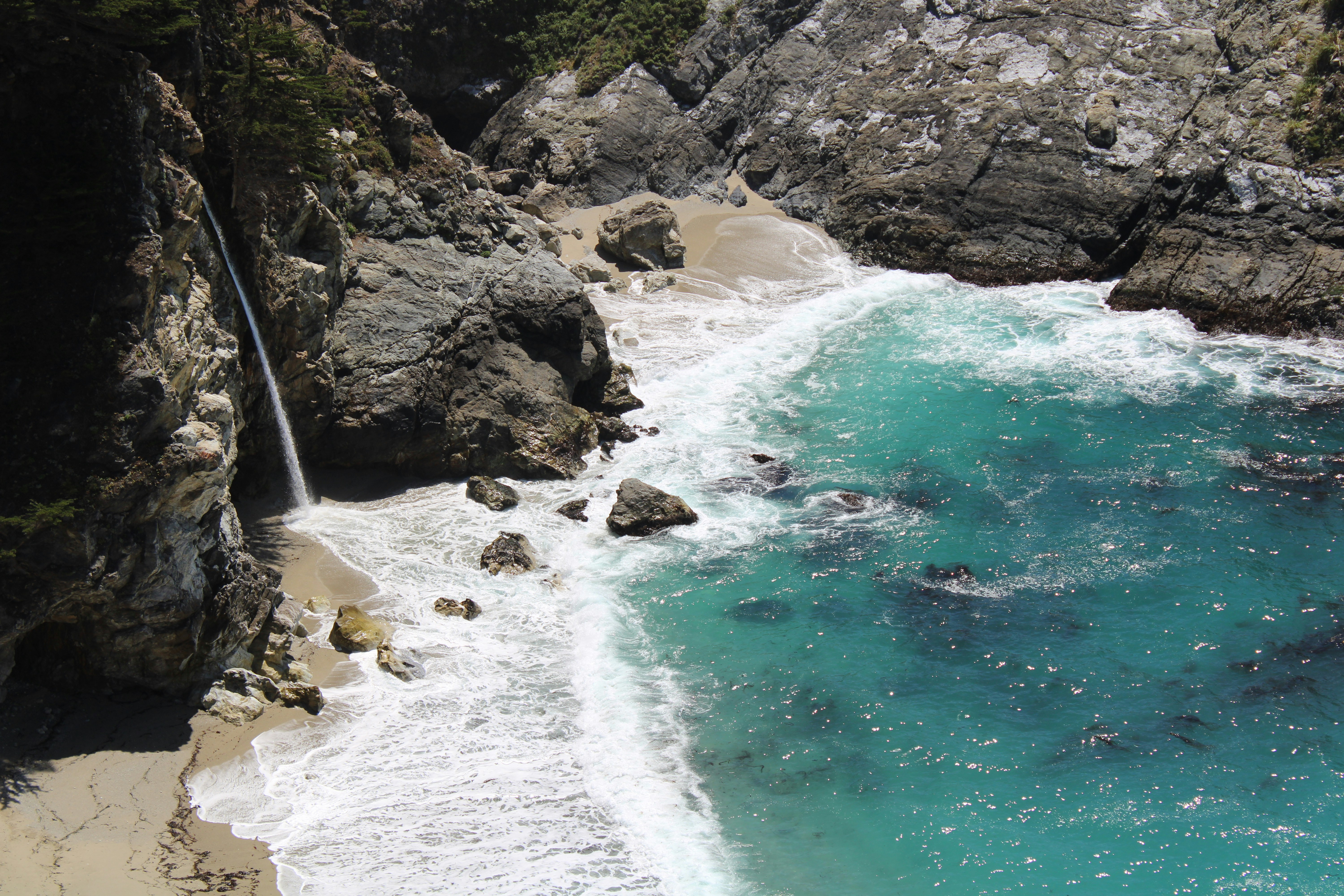 Coastal Terrace: A Narrow Stream Wandering Into Turquoise Waters