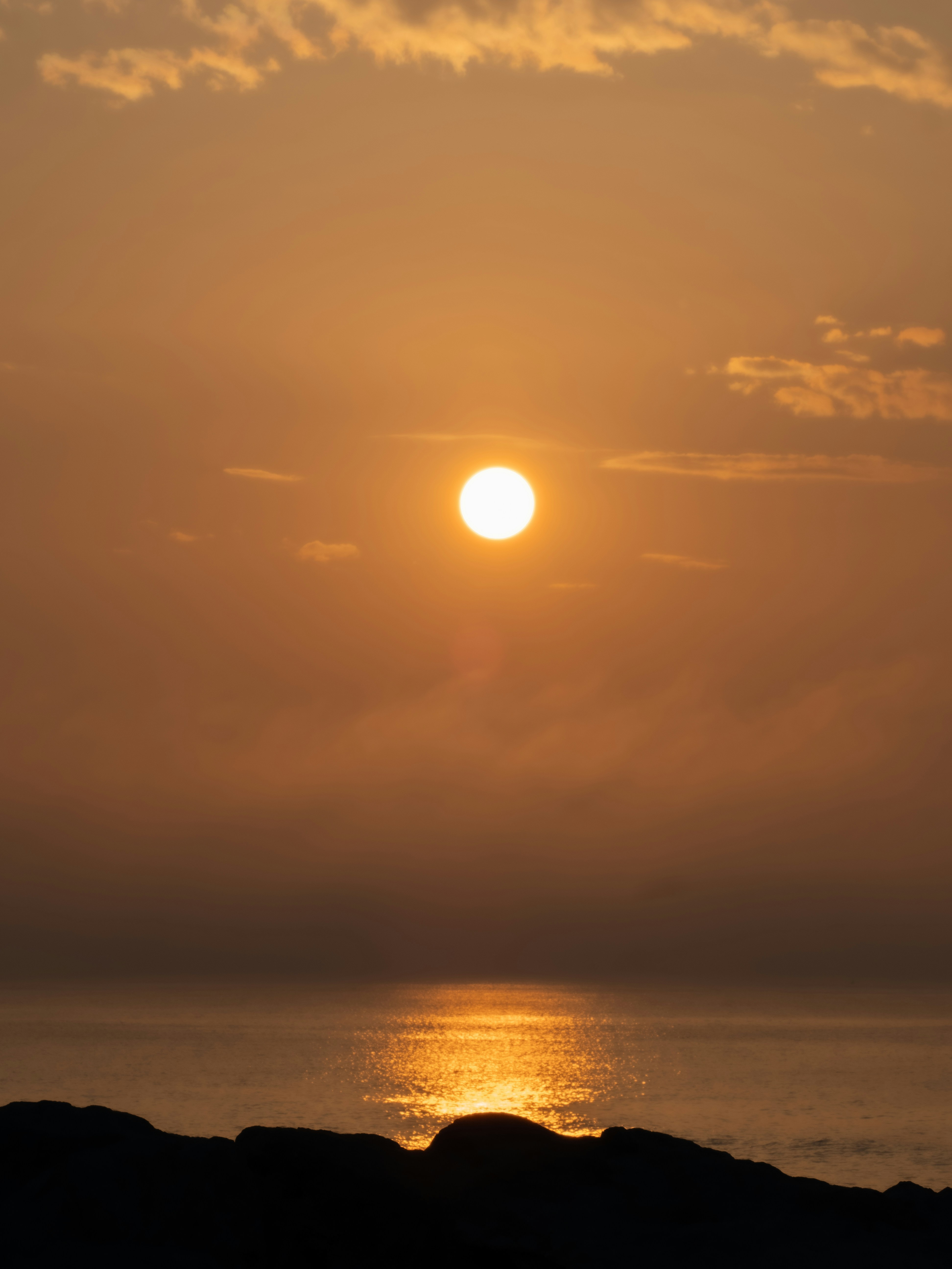 Sunlit Horizon over Quiet Seas