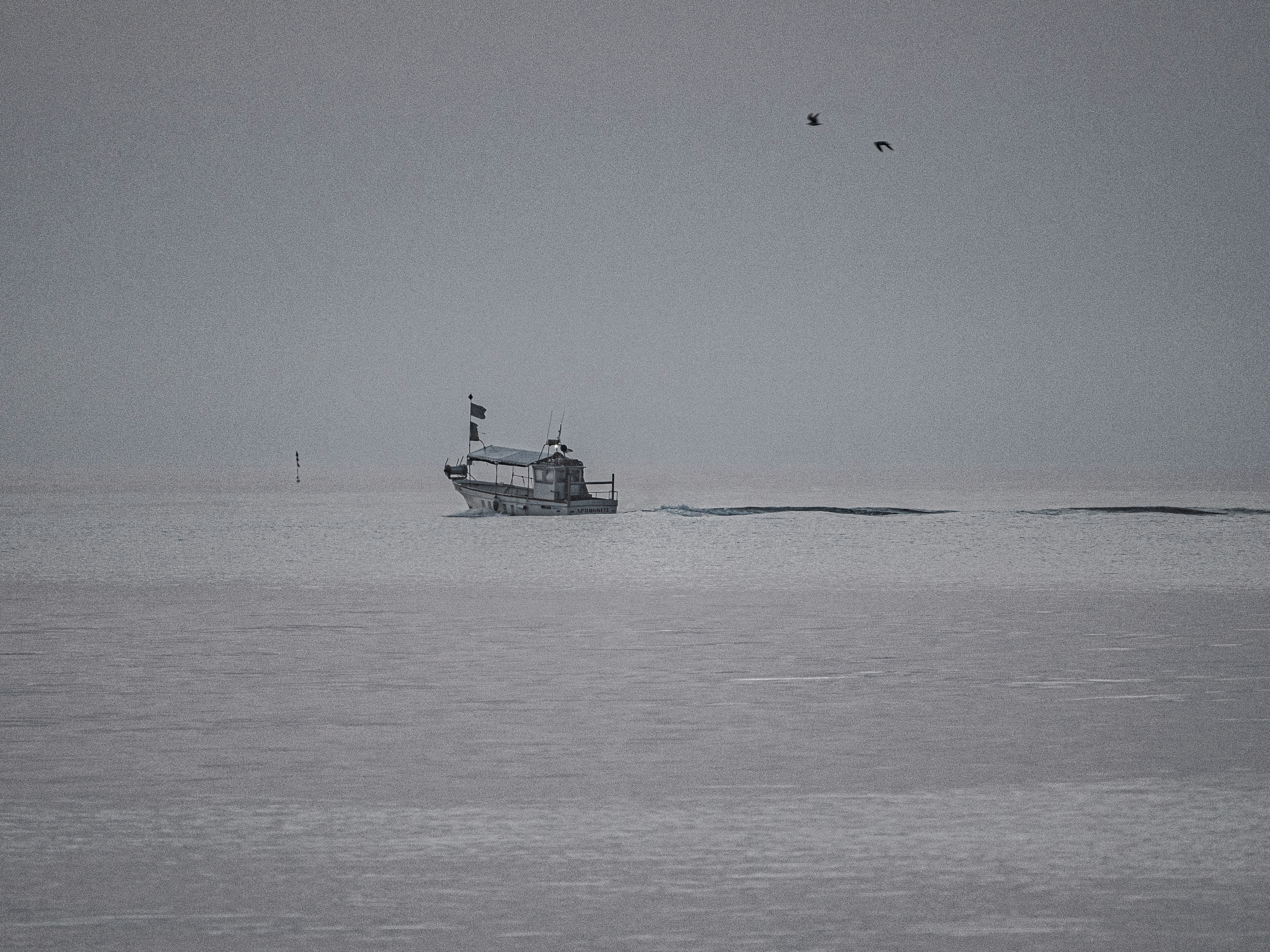 Low-lying Vessel on a Misty Sea