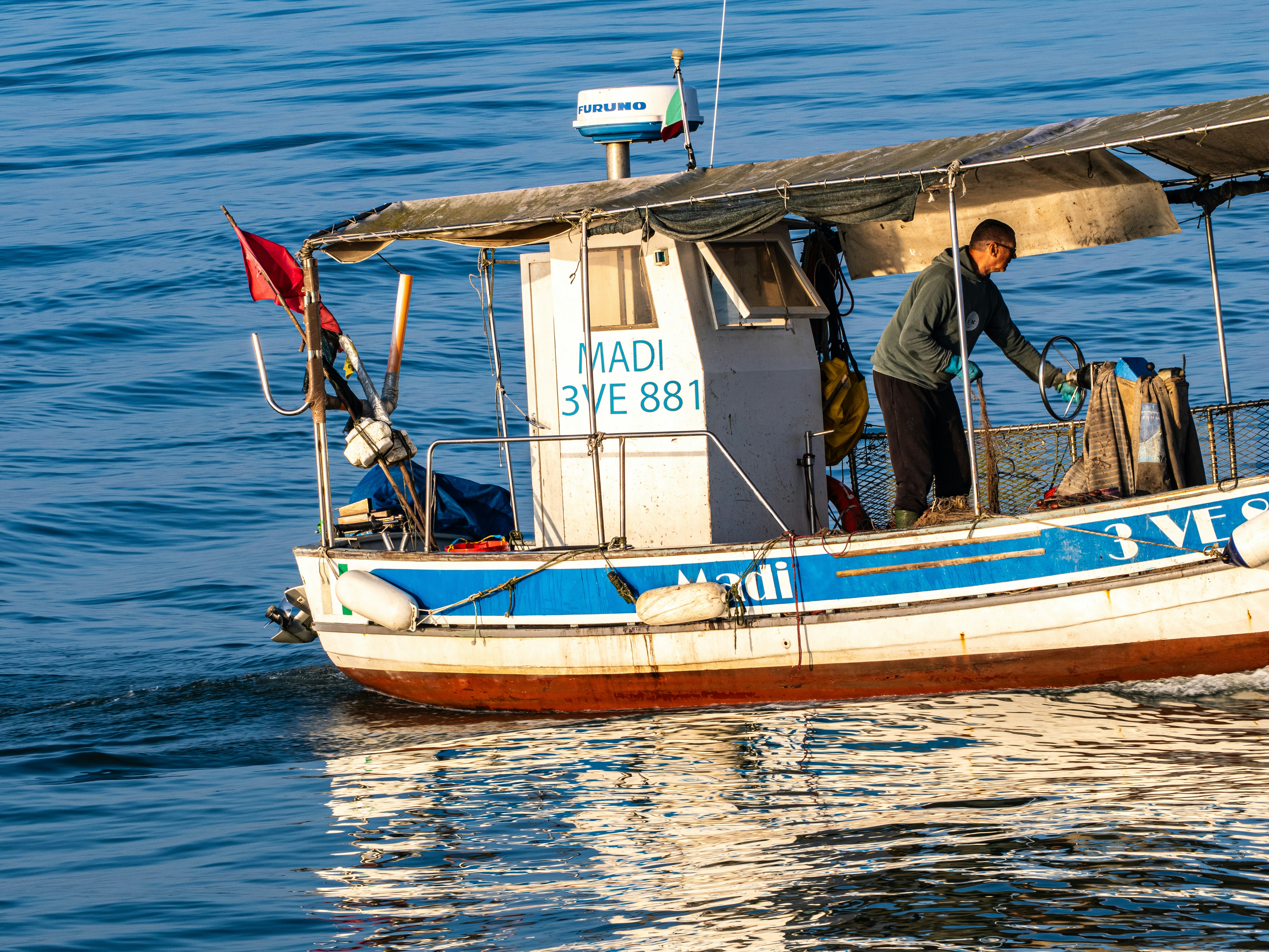 Crewed Fishing Boat in Sunlit Harbor