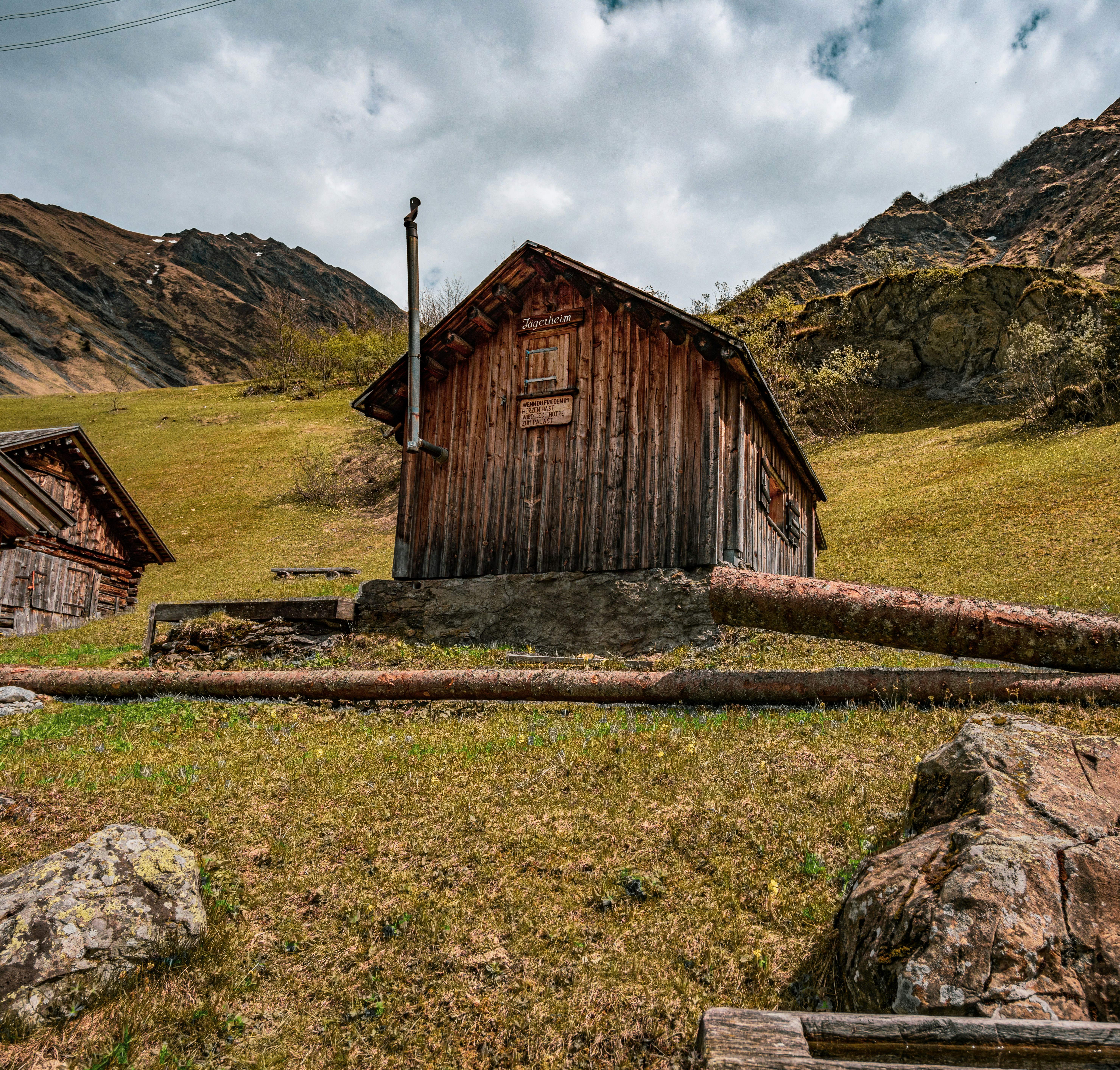 Weathered Alpine Cabin Amid Rolling Hills