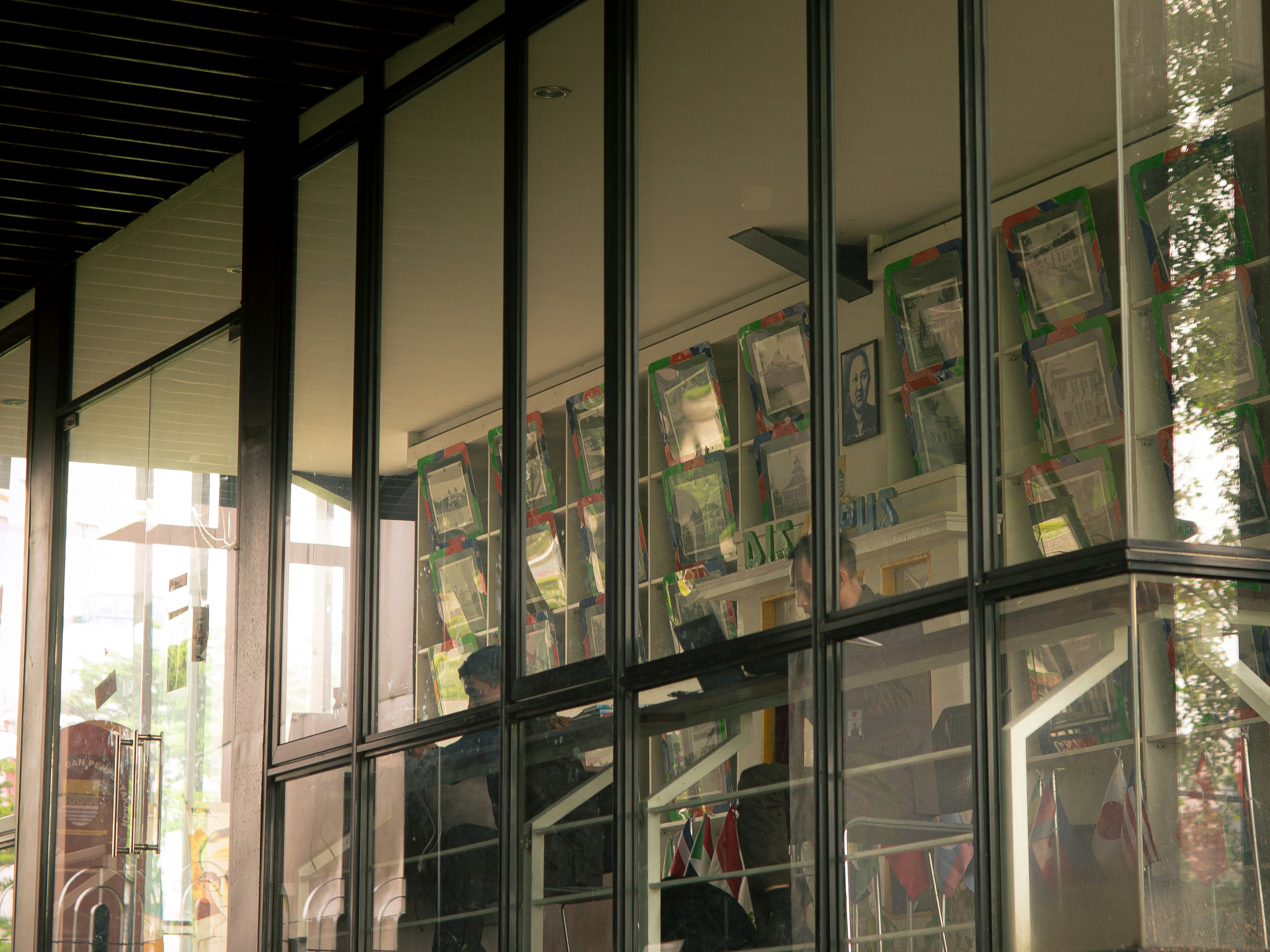 Broken-glass storefront reveals a quiet newsroom inside