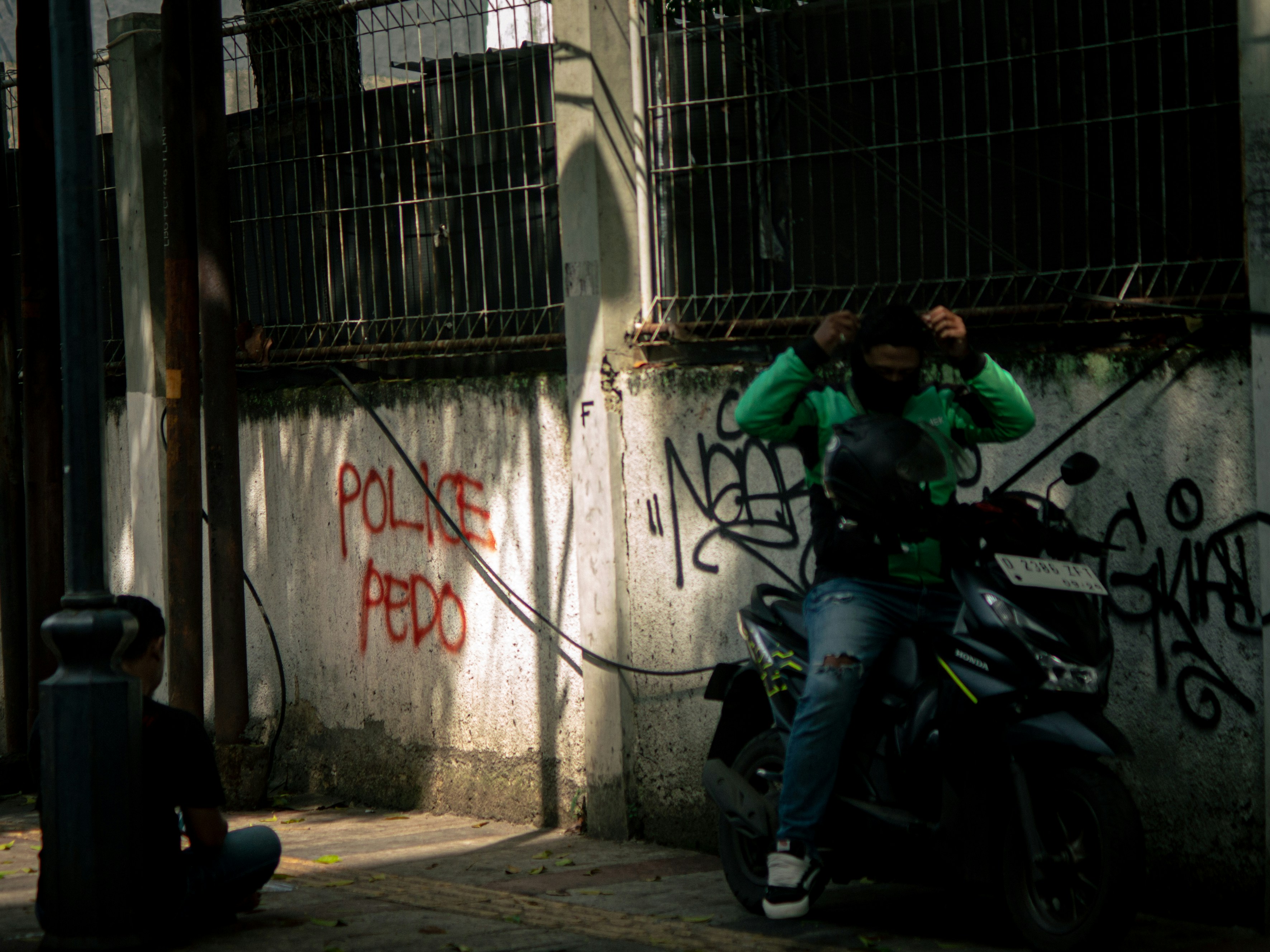 Green-hooded Rider in Urban Graffiti Light