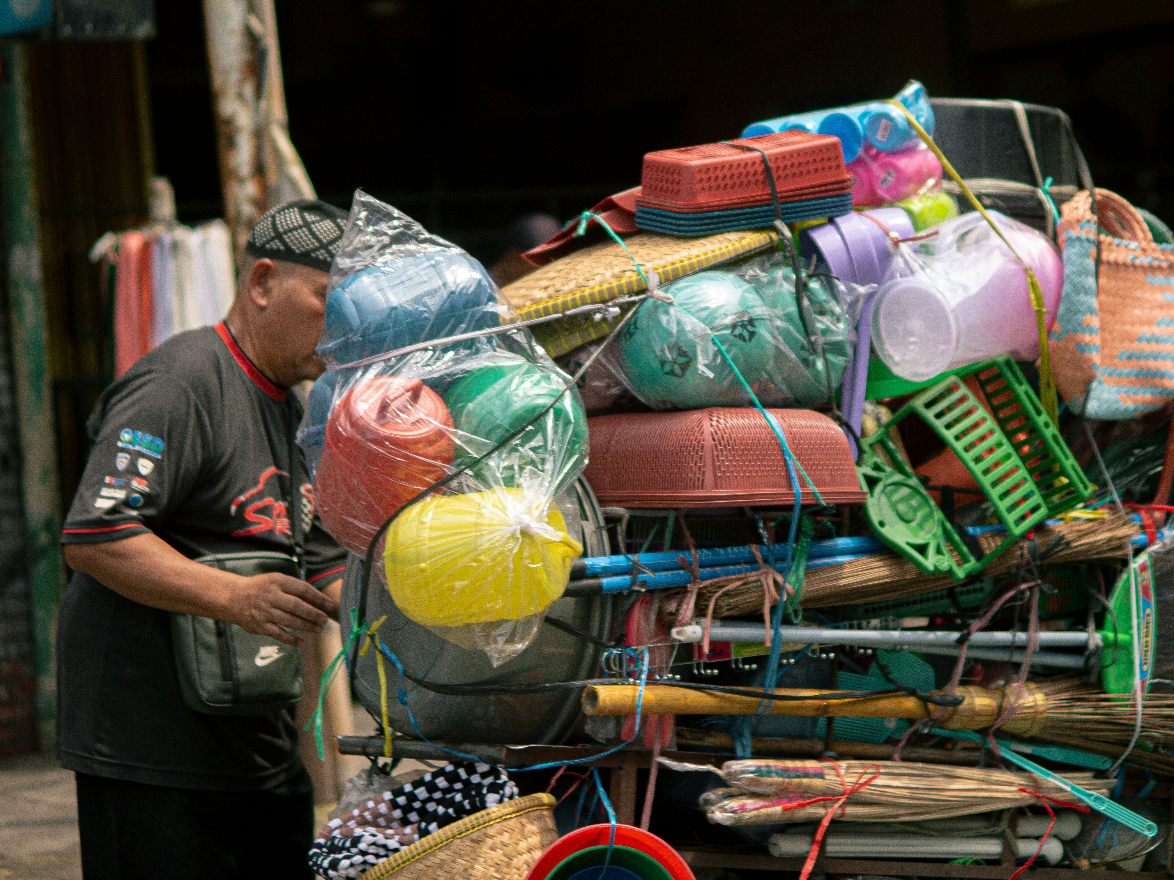 Man and Pile of Recycled Goods: A Colorful Tangle of Everyday Objects