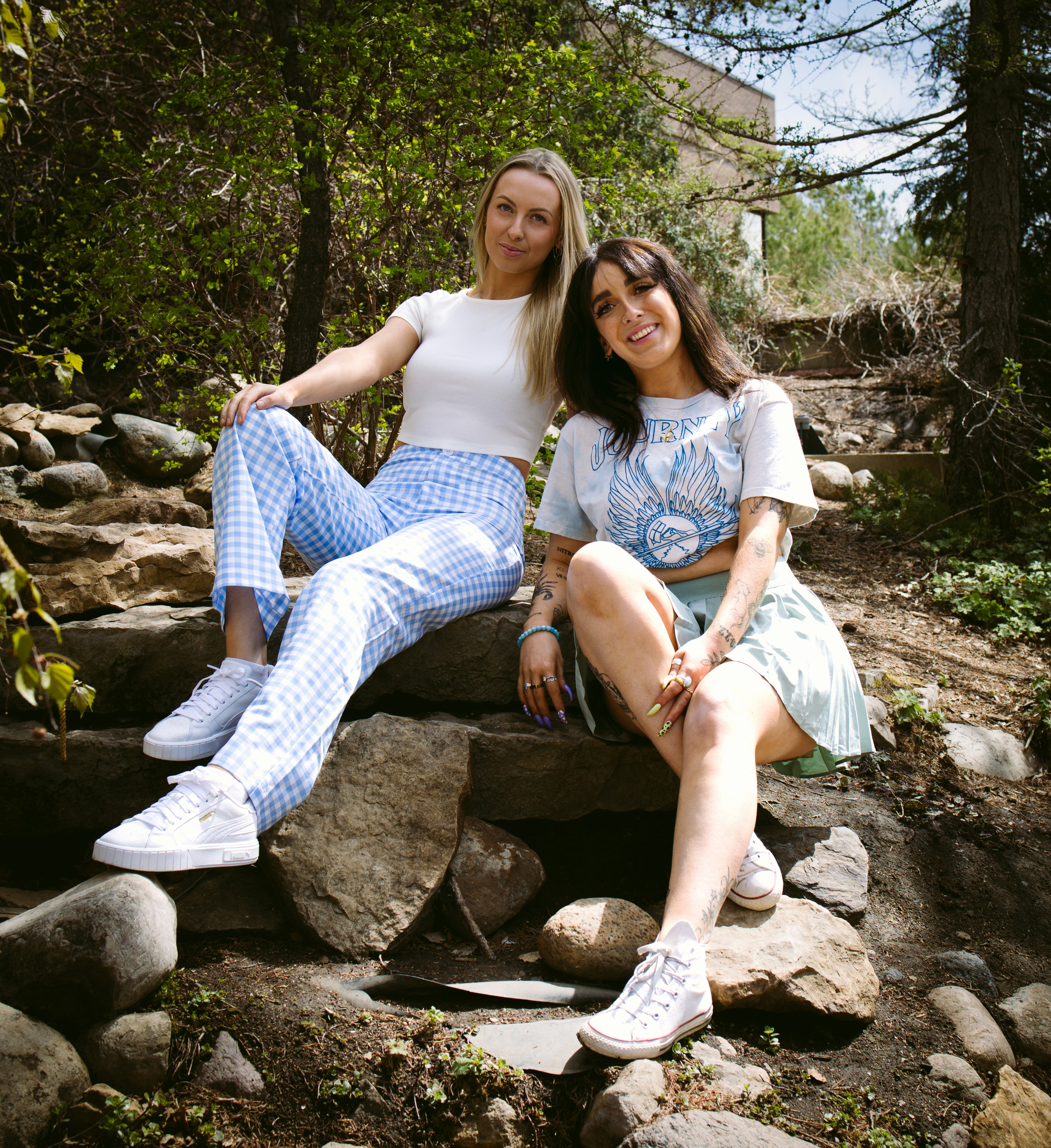 Sunlit Steps: Two Friends Resting on Garden Stones