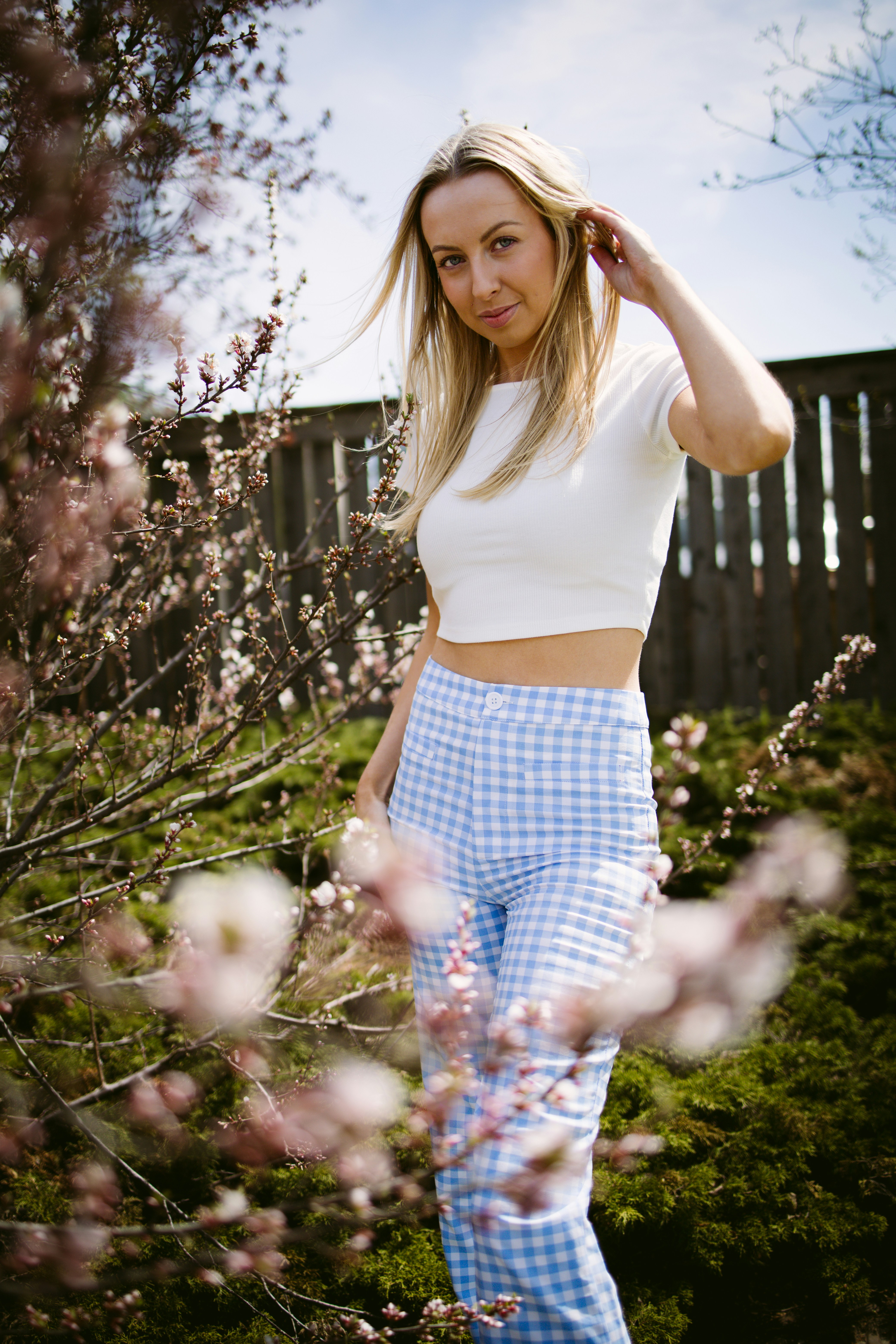 Springlight Portrait: A Casual Confidence Among Blossoms