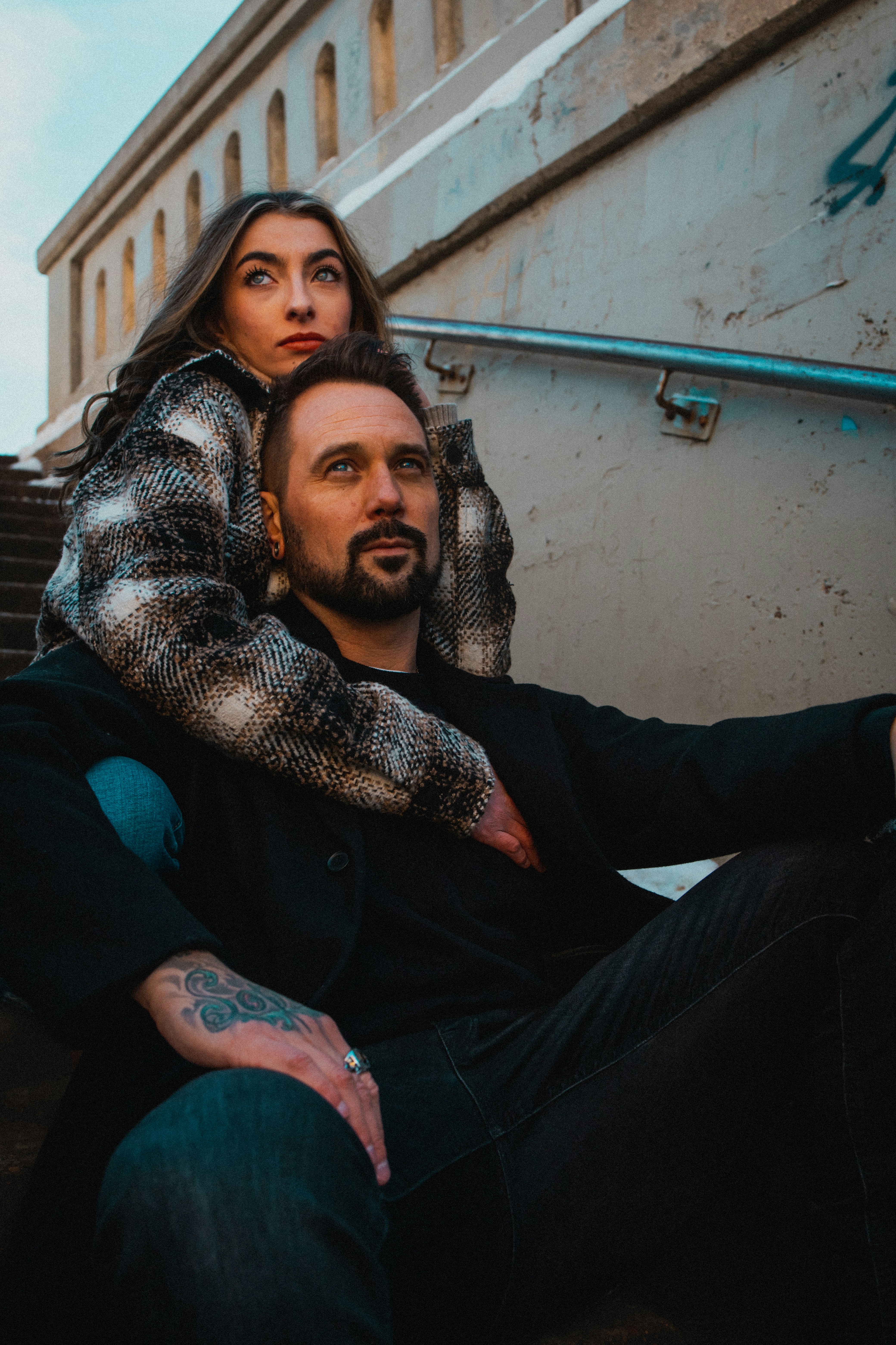 Rooftop Embrace: A Quiet Moment Between Partners on Stairs