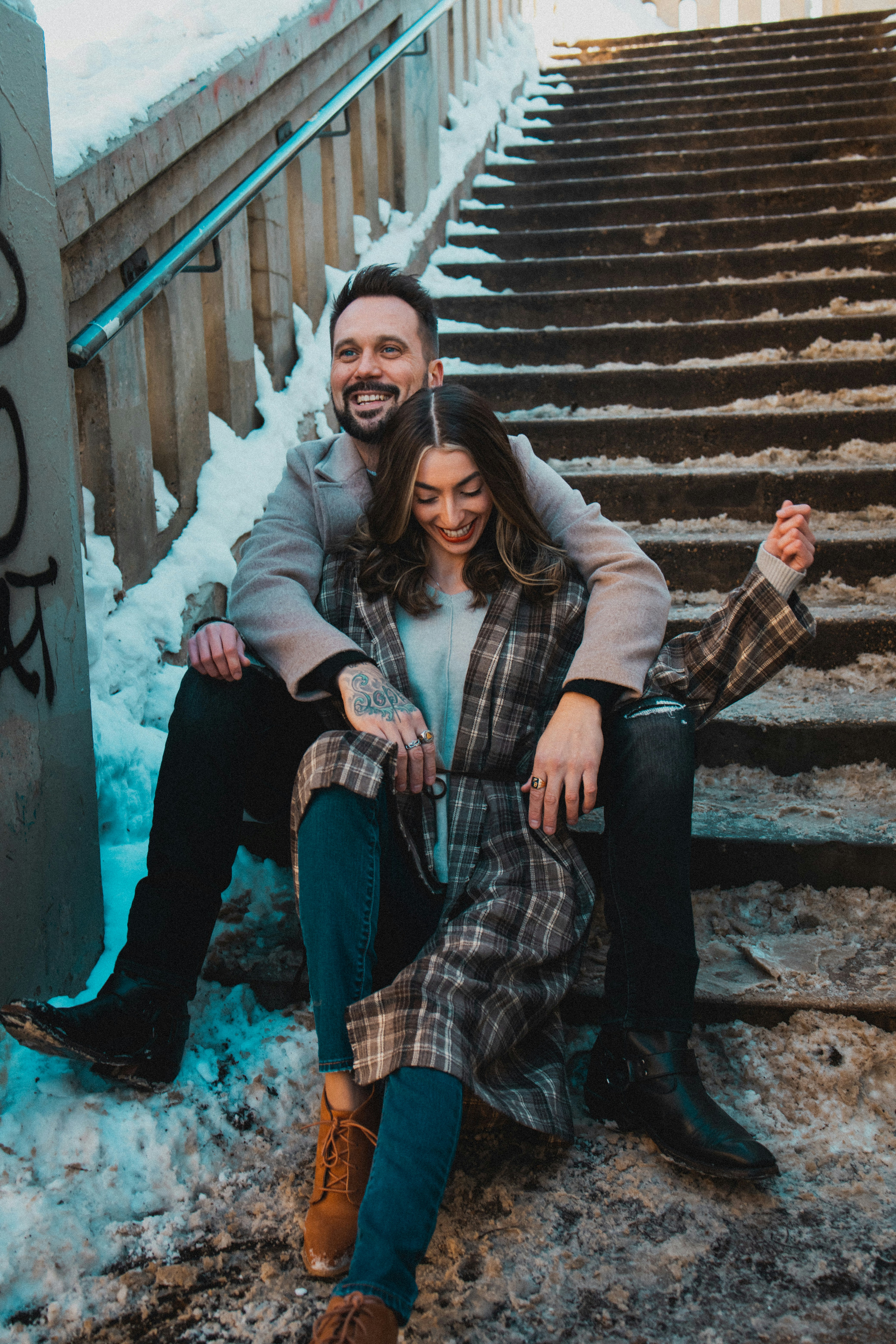Winter Warmth: A Couple Shares Quiet Joy on Snowy Steps