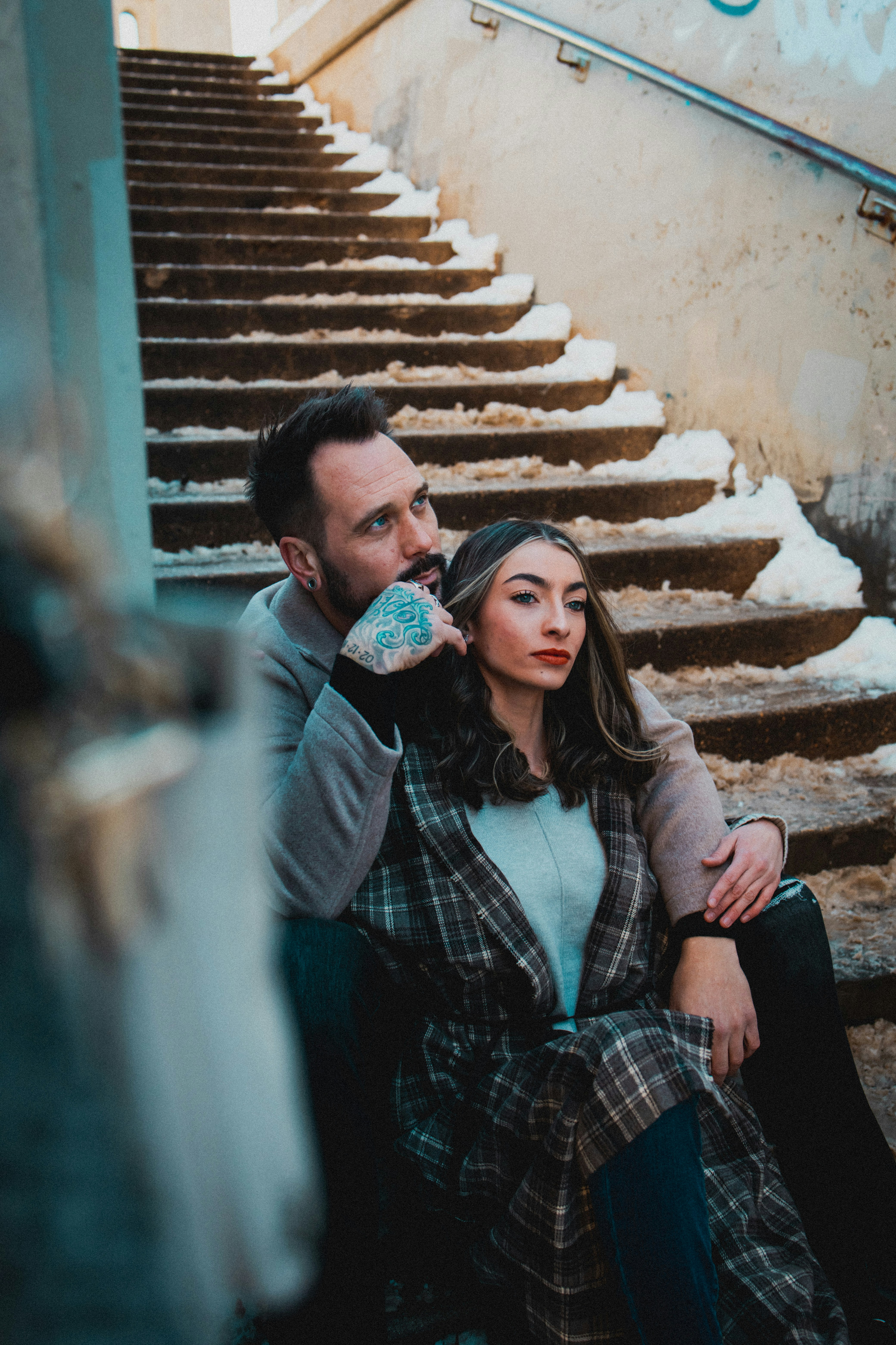 Couple on the Snow-Worn Steps: Quiet Intimacy at Dusk