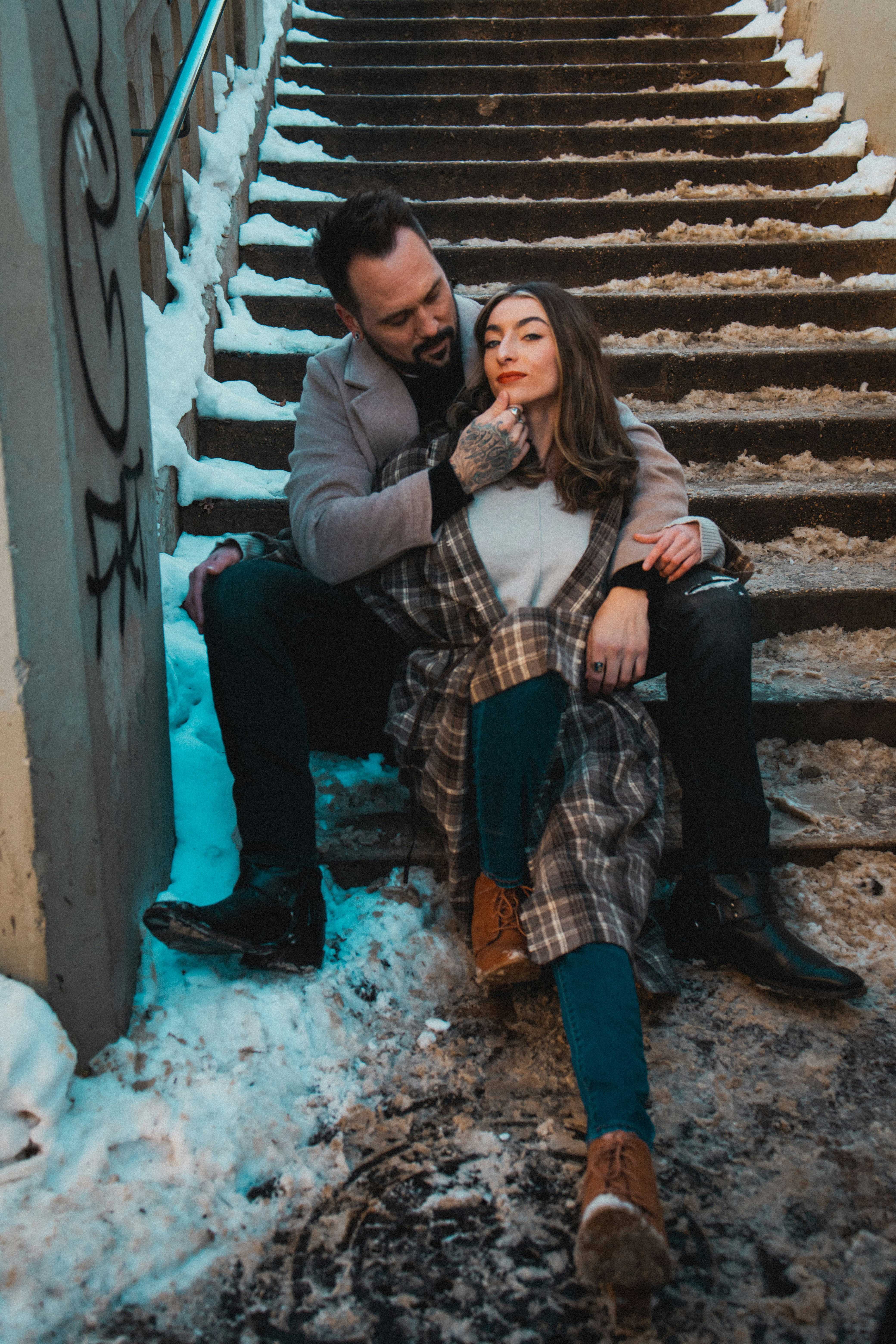 Winter Staircase Embrace: A Quiet Moment Between Two Lovers