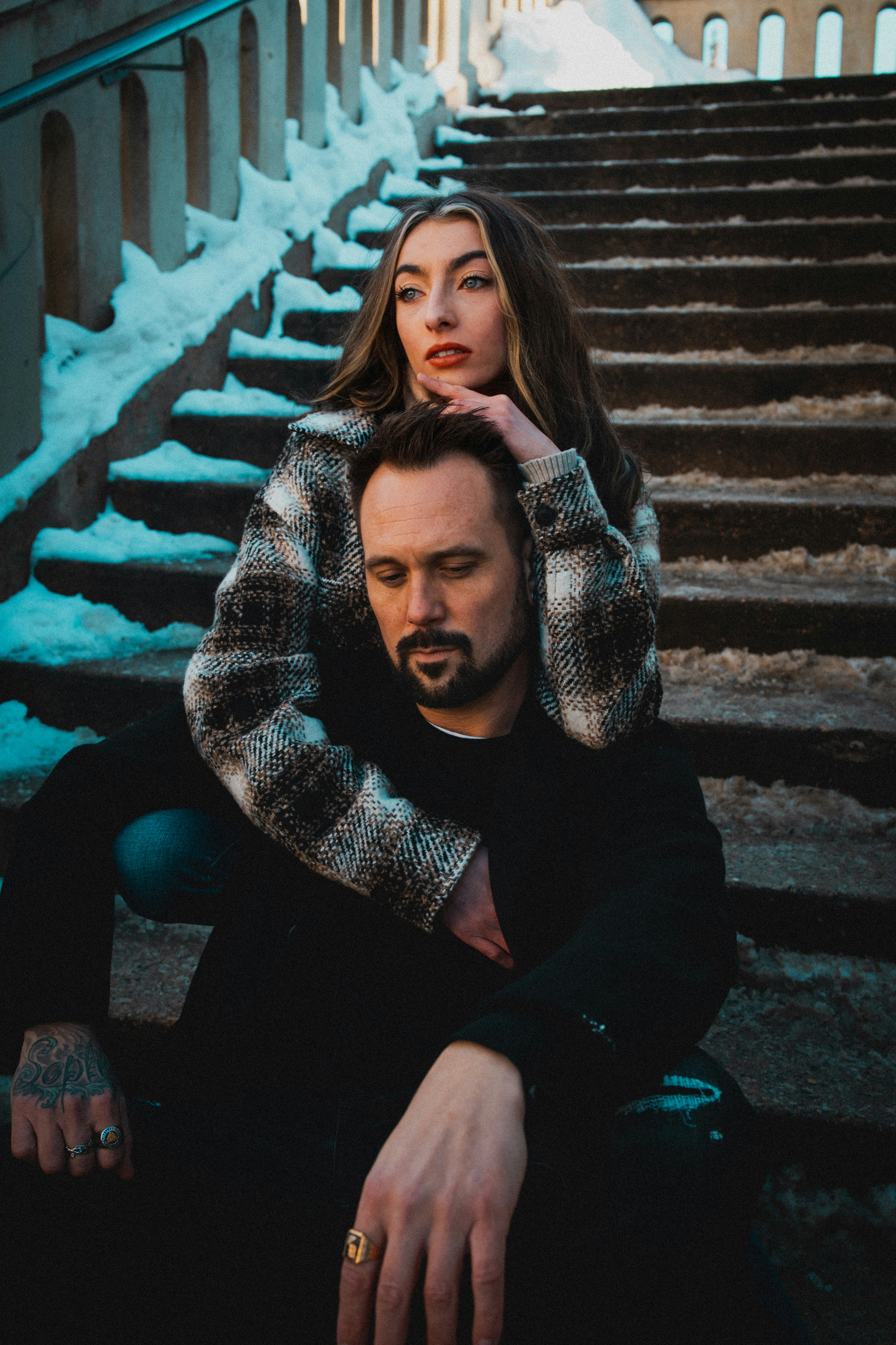 Two Voices on the Stairs: A Quiet Embrace Beneath Winter Steps