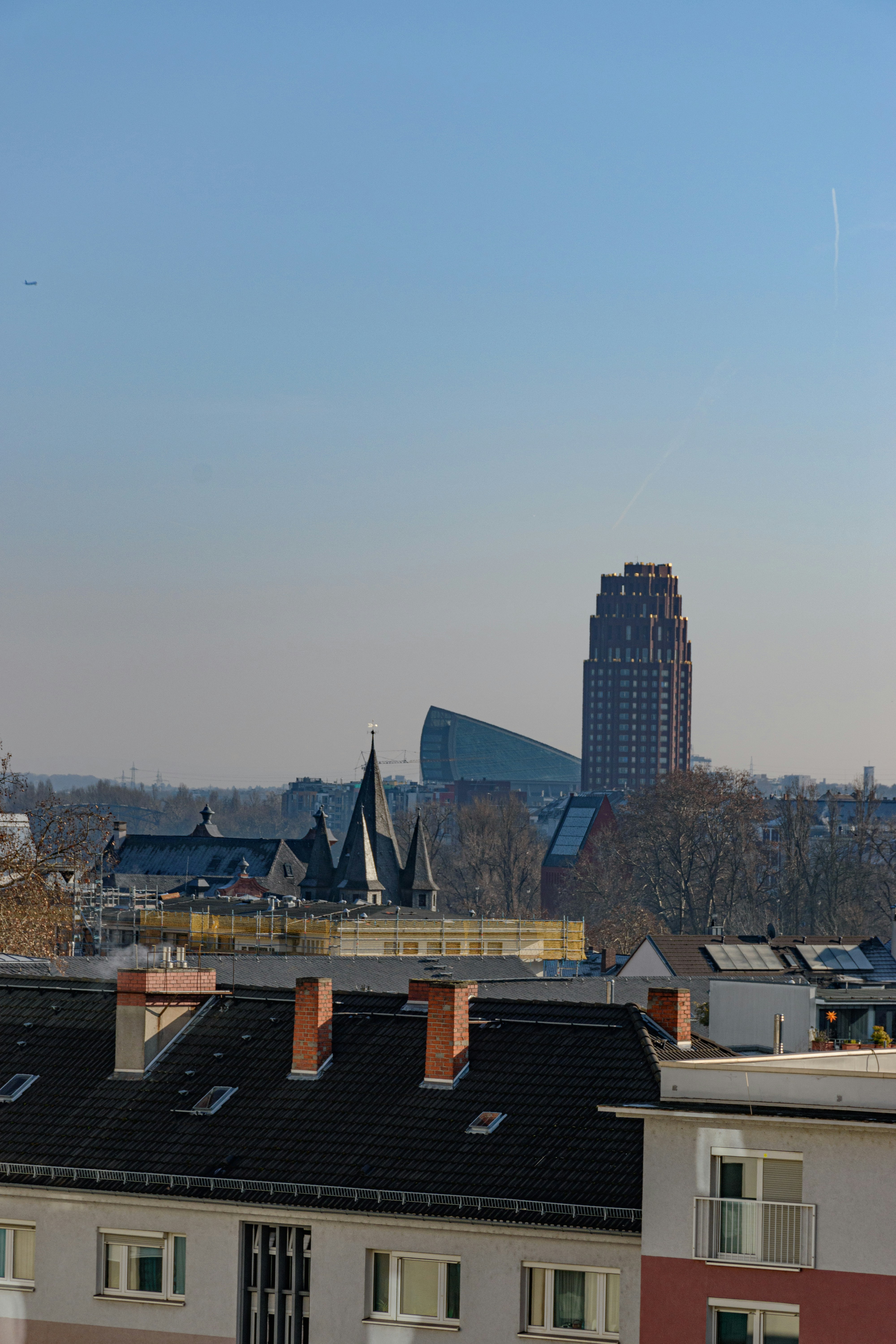 Skyline Threaded with Time: A Quiet City Rise Against a Clear Afternoon