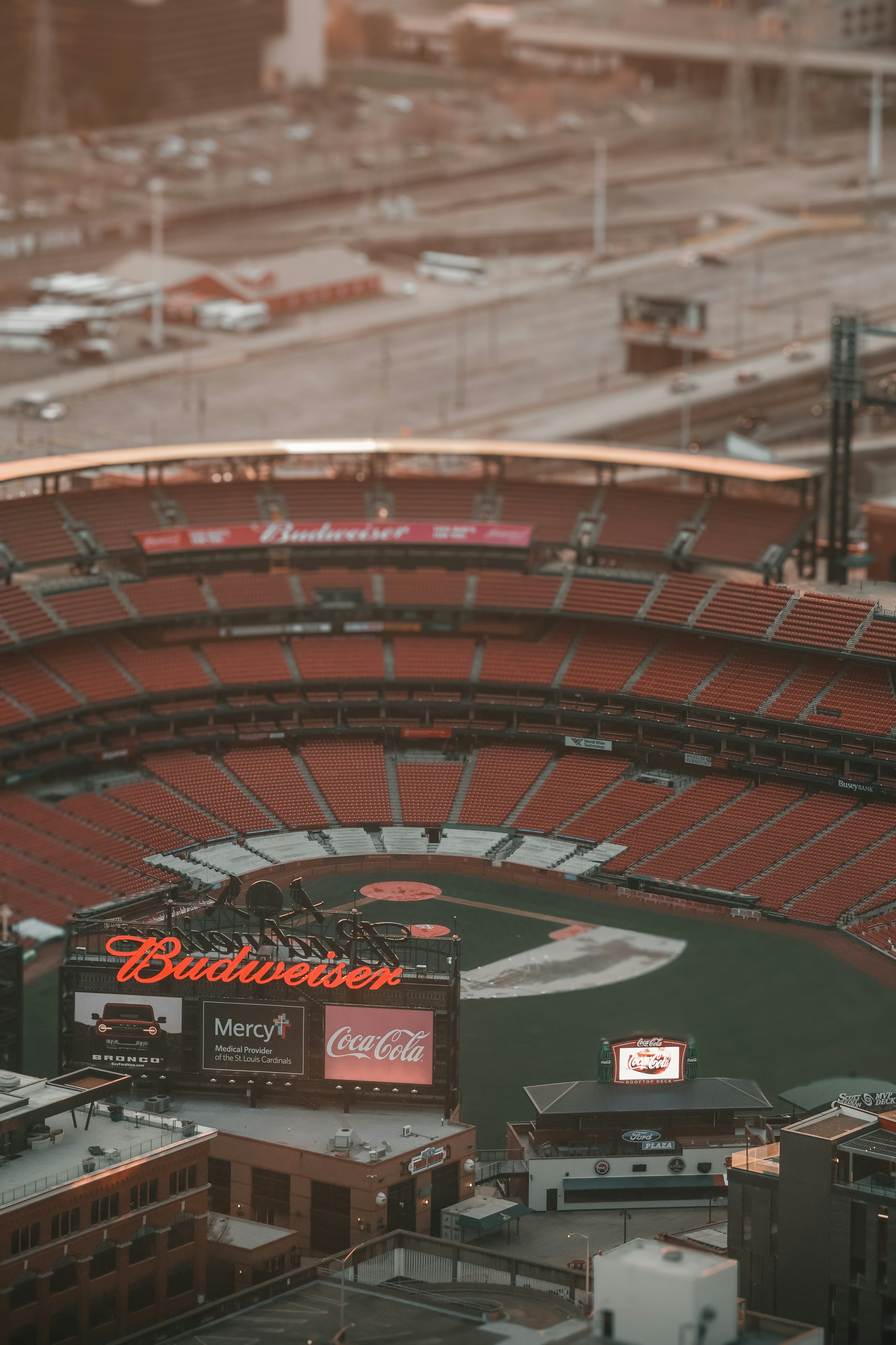 Evening at the Diamond: A Budweiser Sign Framing the Empty Stands
