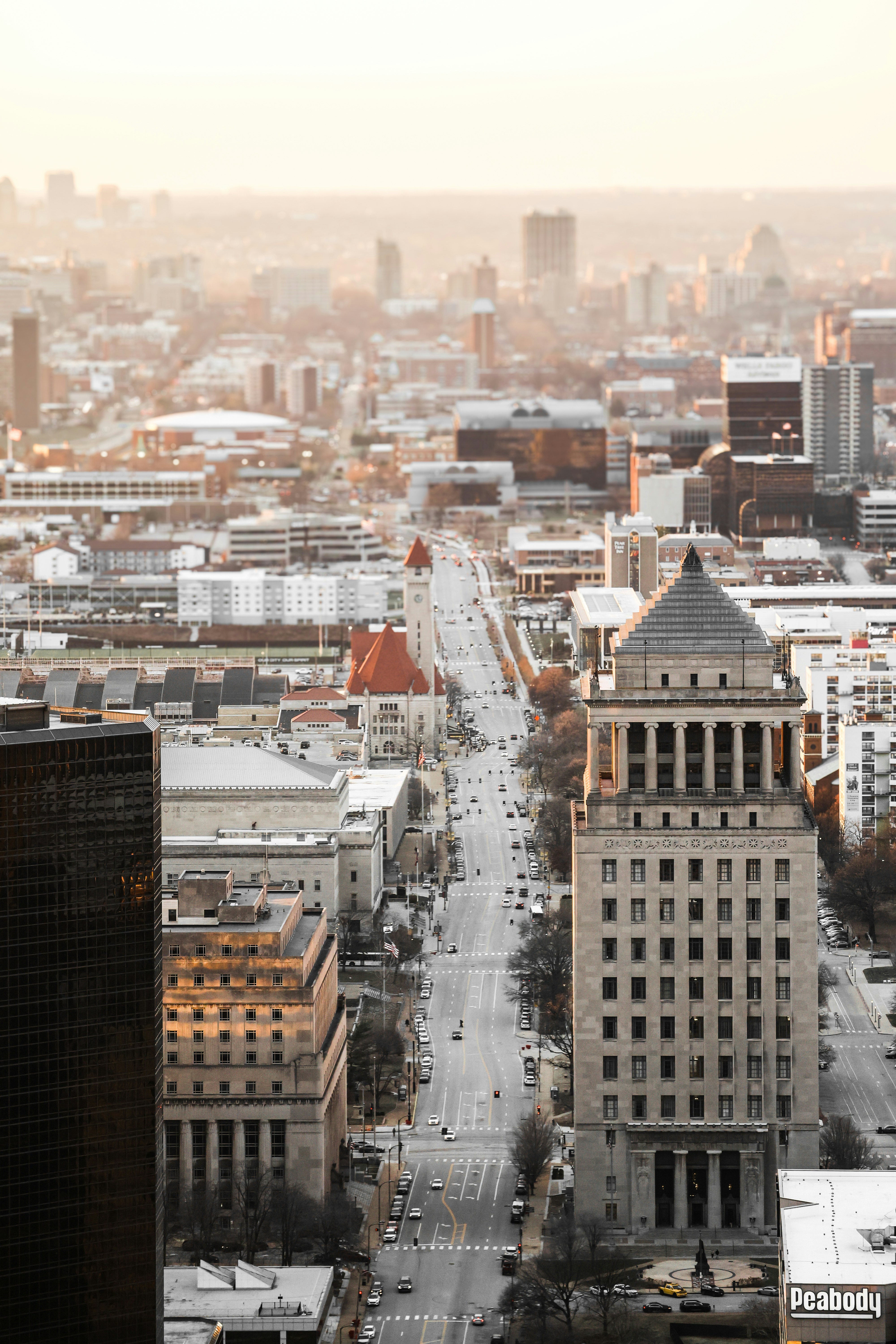 A City Street Pierces the Dawn: Towers and Topped Roofs Align Under Soft Light