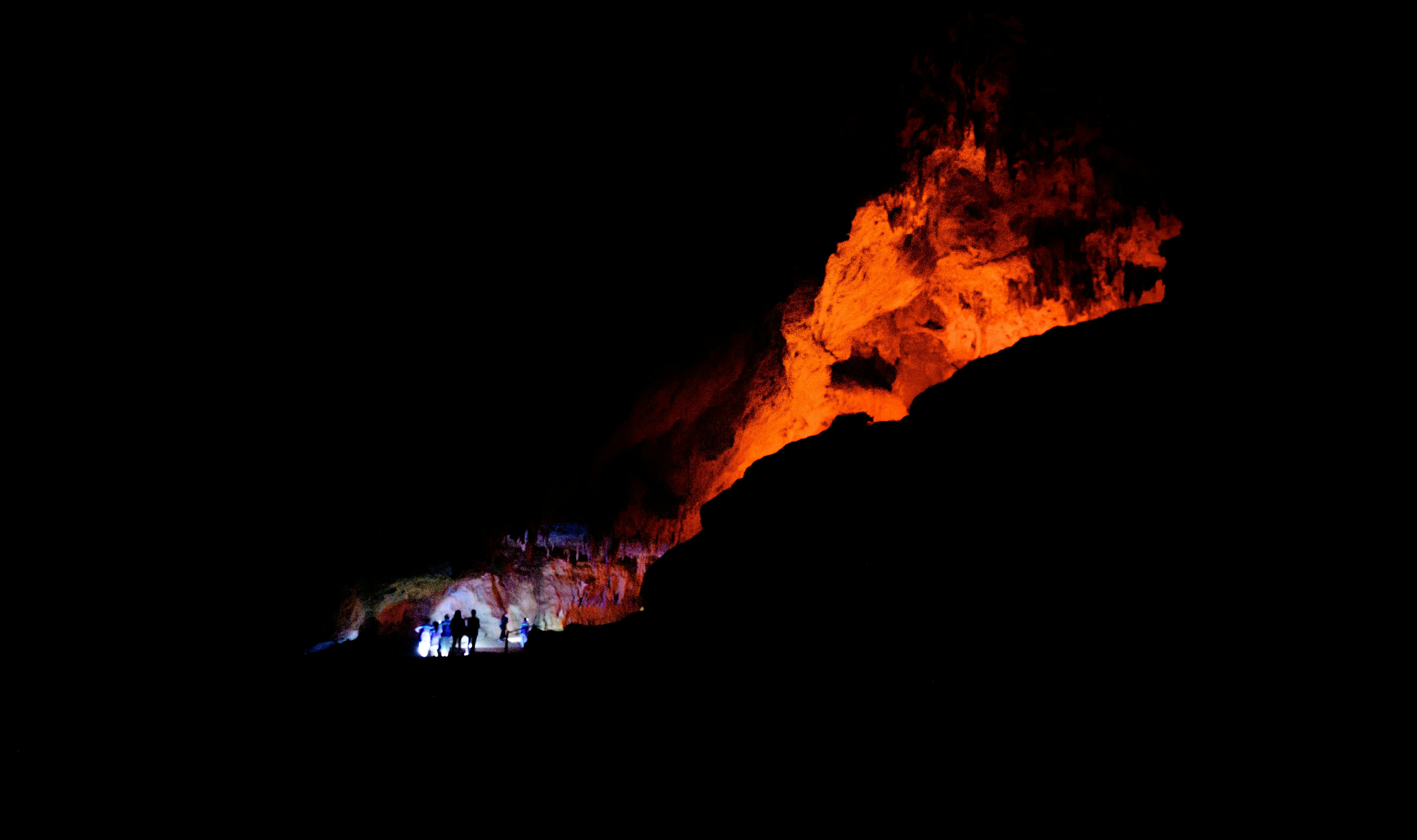 Luminescent Cave: A Midnight Expedition Illuminating a Fiery Ridge