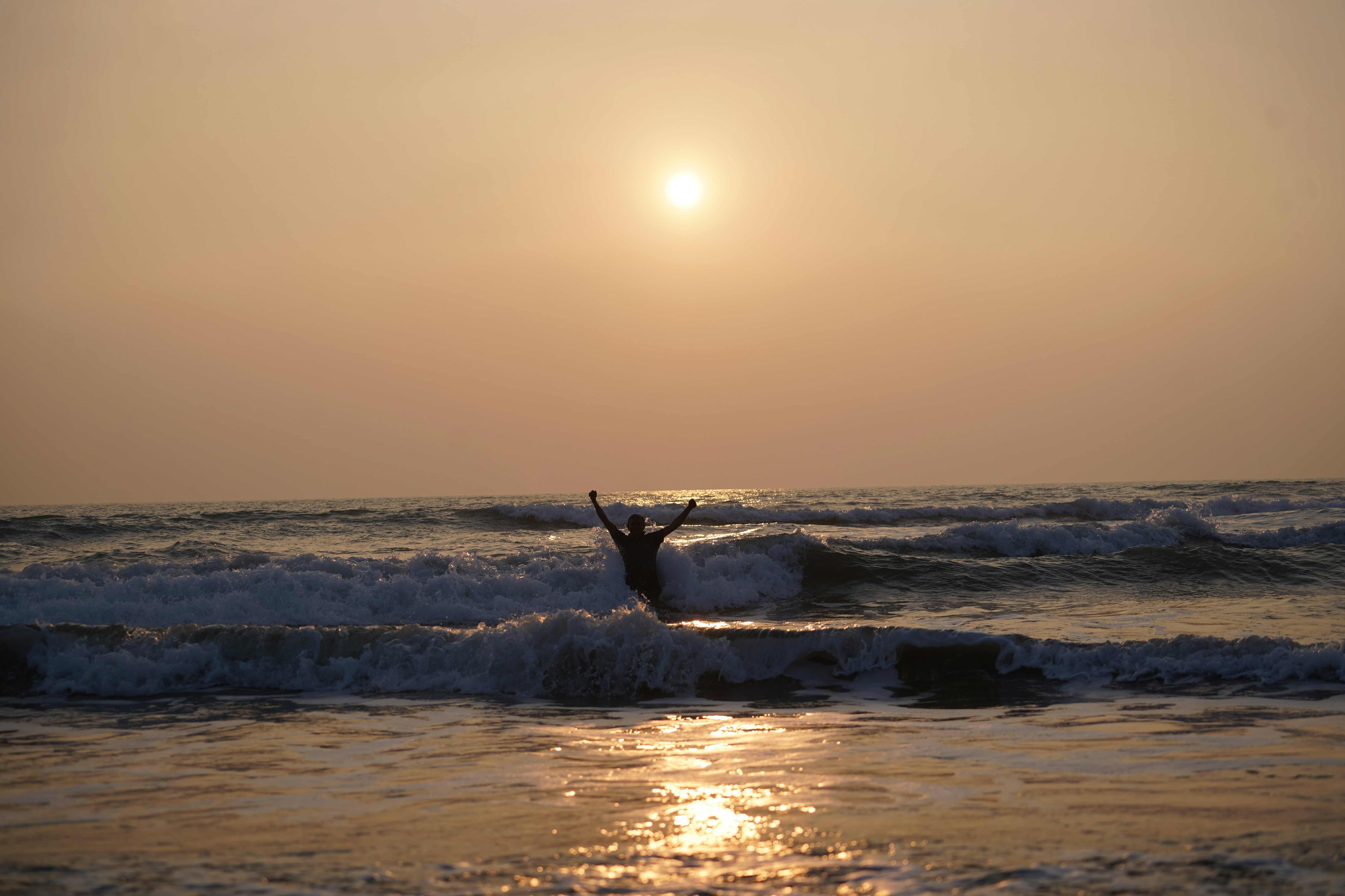 Sunlit Pose: A Silhouette Celebrates at Dusk