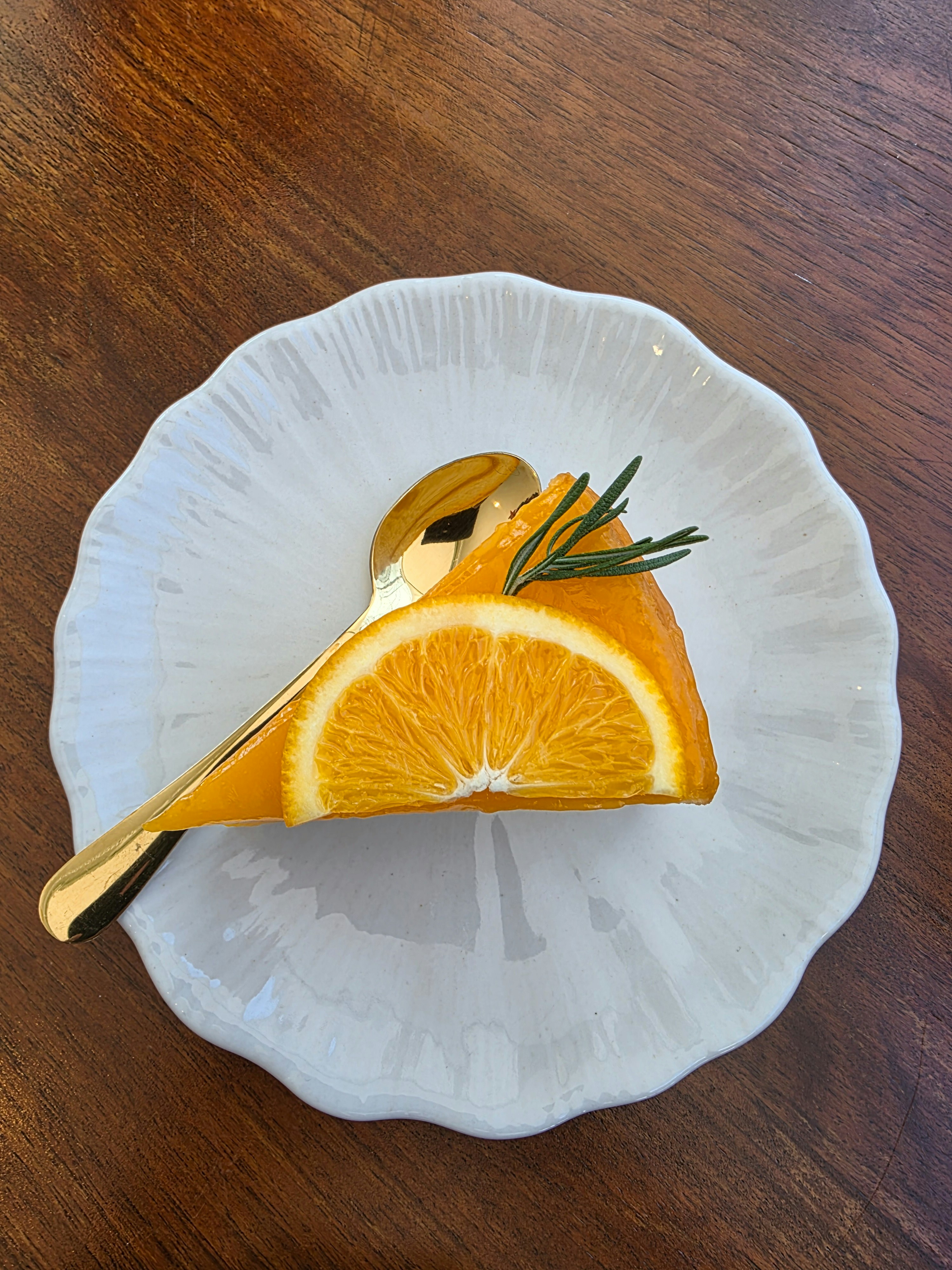 Citrus Slice on a Soft White Plate with Rosemary