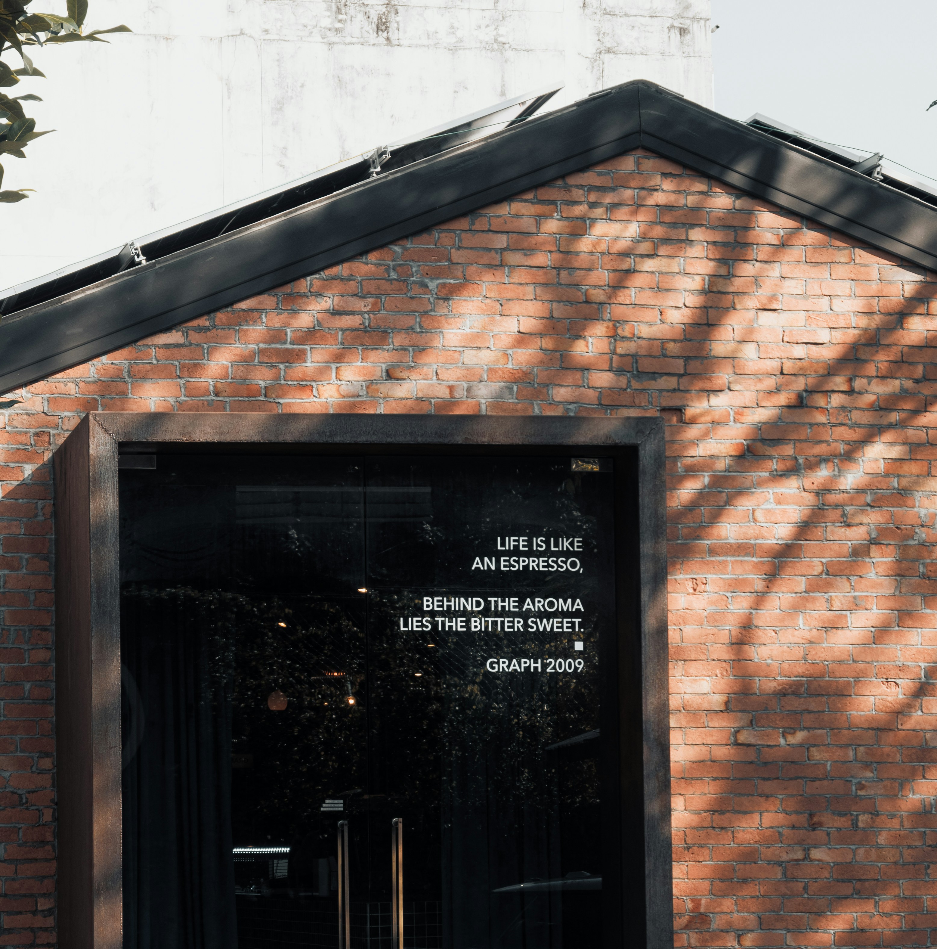 Brick Facade with Shadowed Gables and Quiet Entrance