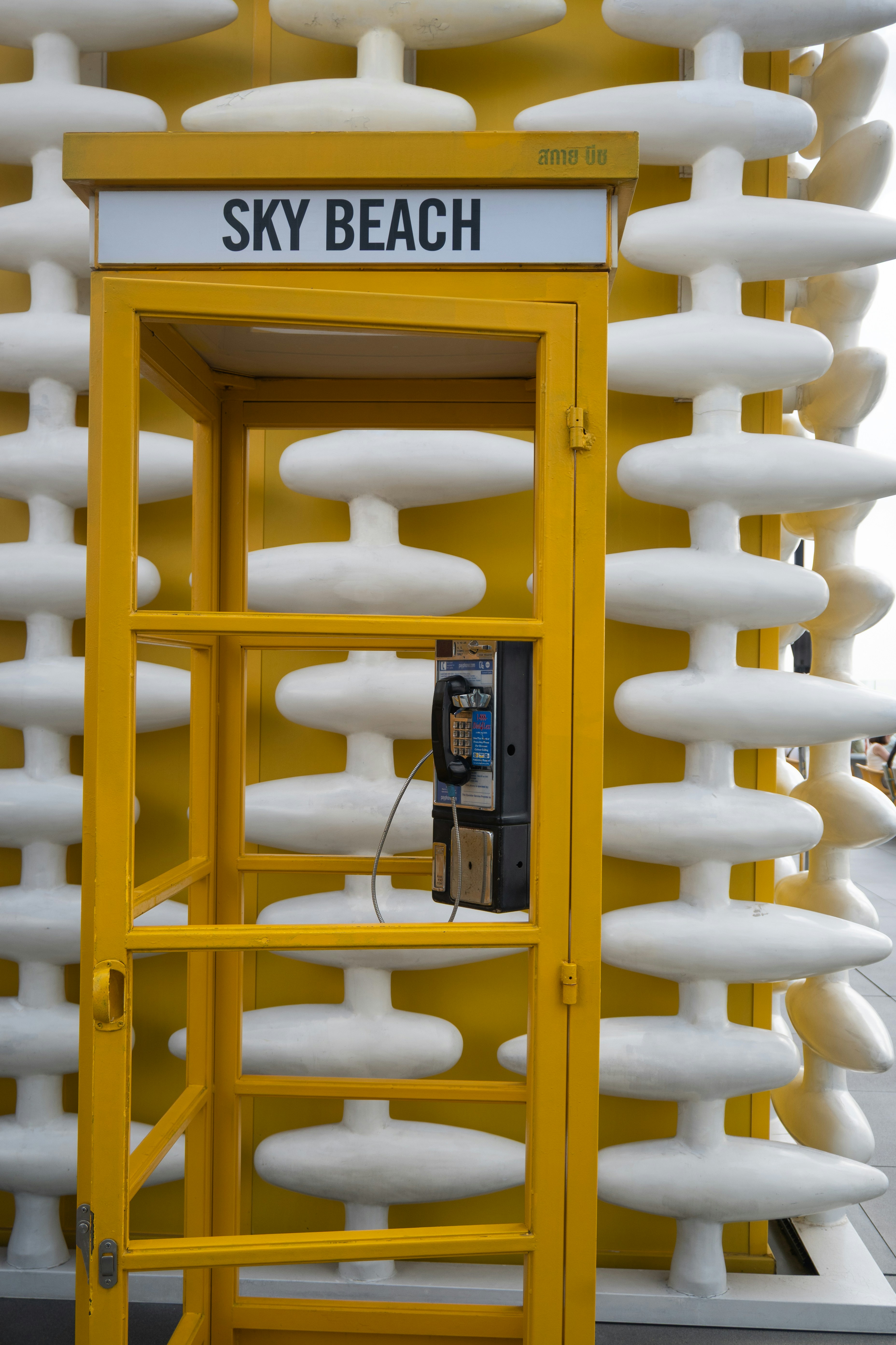 Yellow Kiosk Frame: Sky Beach Sign Beyond the Geometric Retro Grid