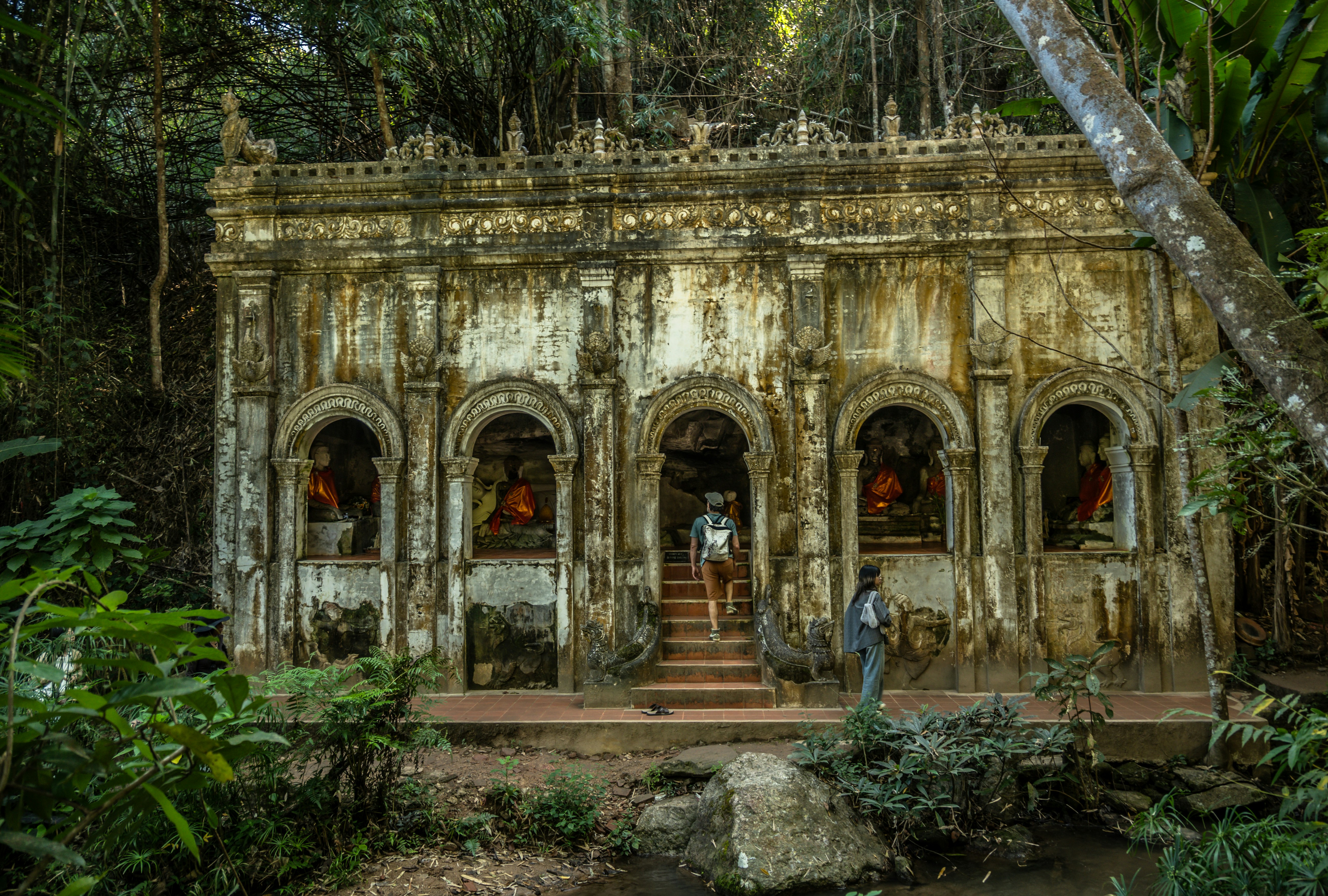 Heritage in the Grove: A Weathered Temple Framed by Greenery