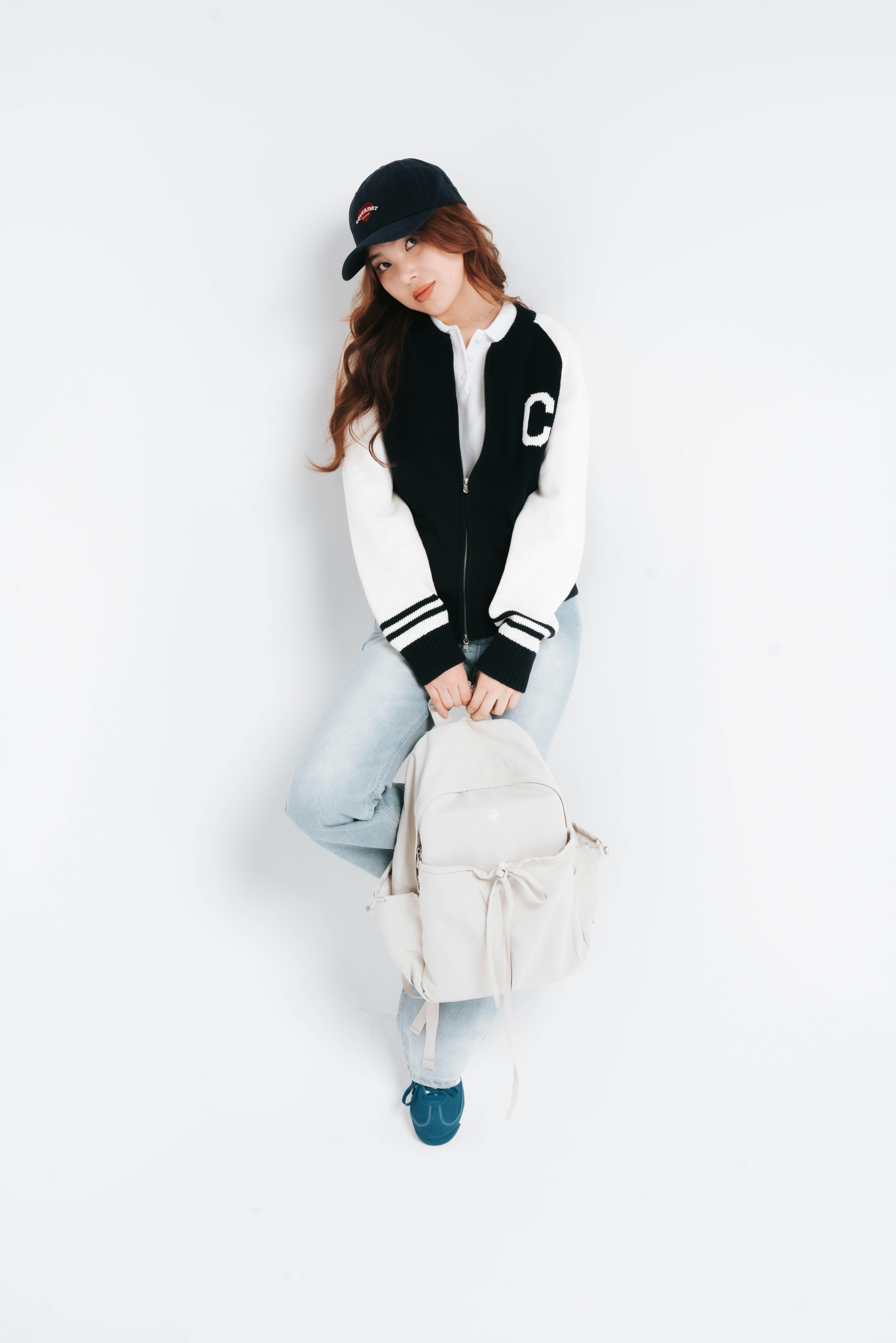 Youthful Poise: A Casual Portrait in White and Black