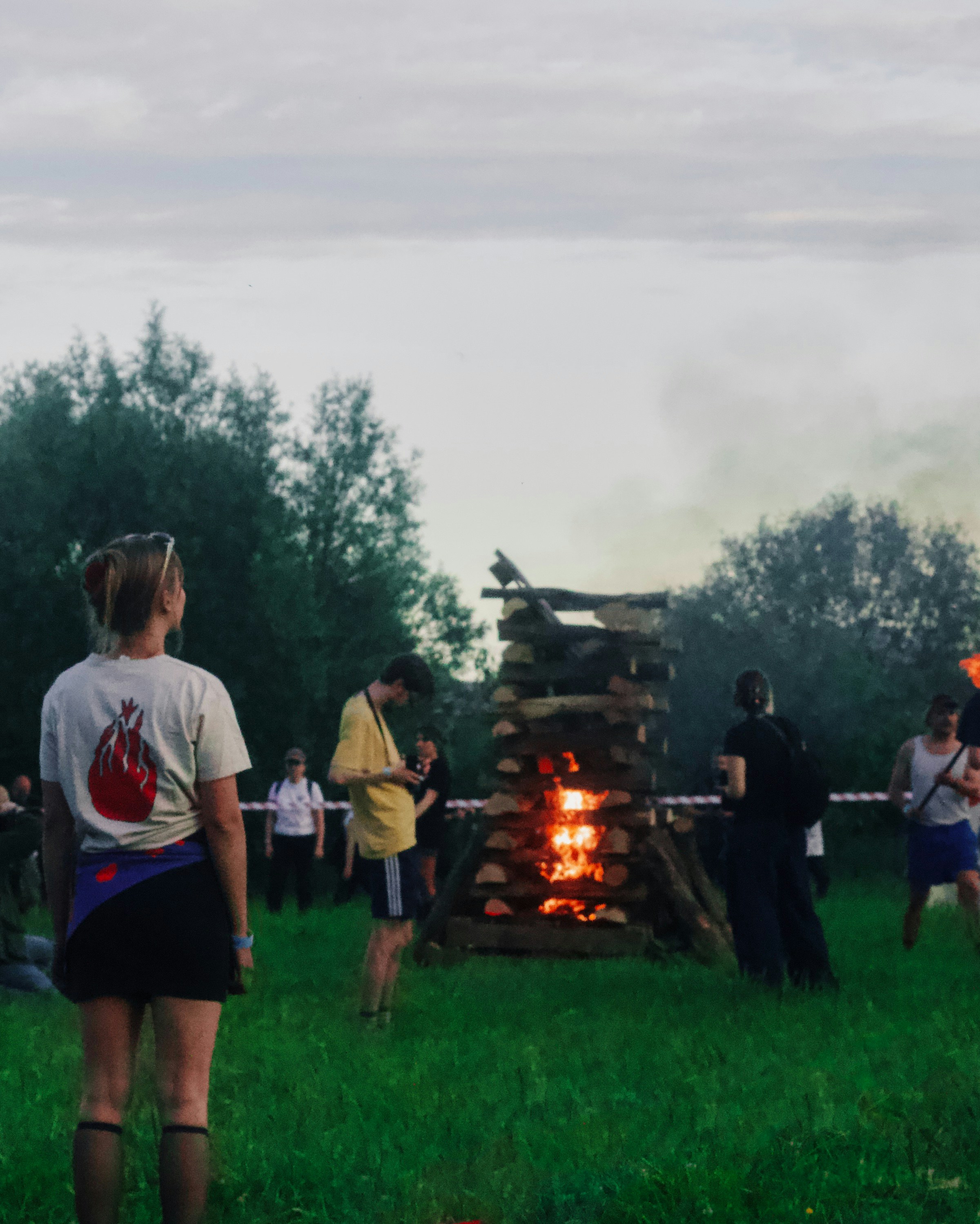 Firelight Gathering: People Around a Bonfire in an Open Field