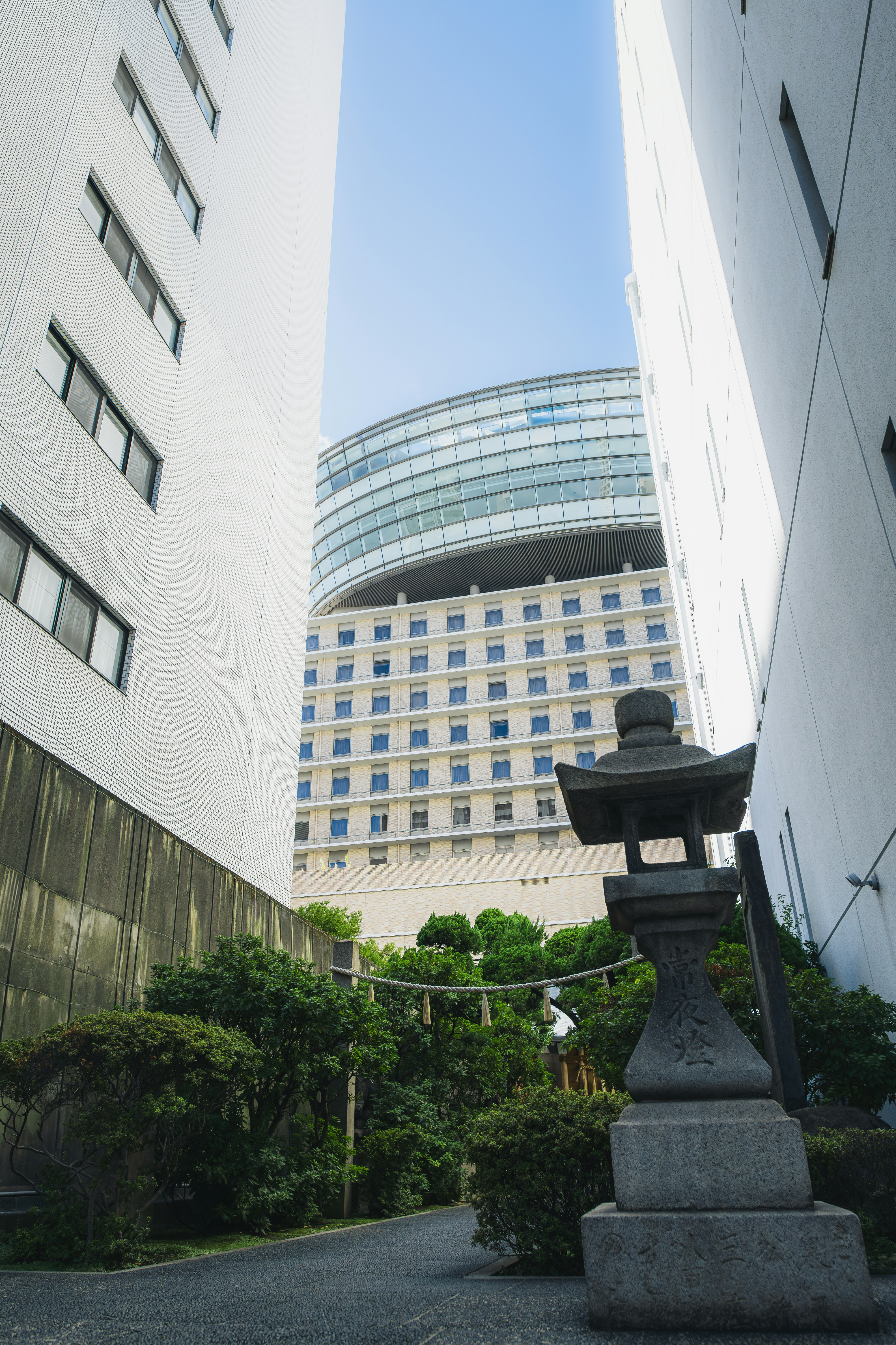 Between Sky and Stone: Urban Lantern Framed by Modern Architecture